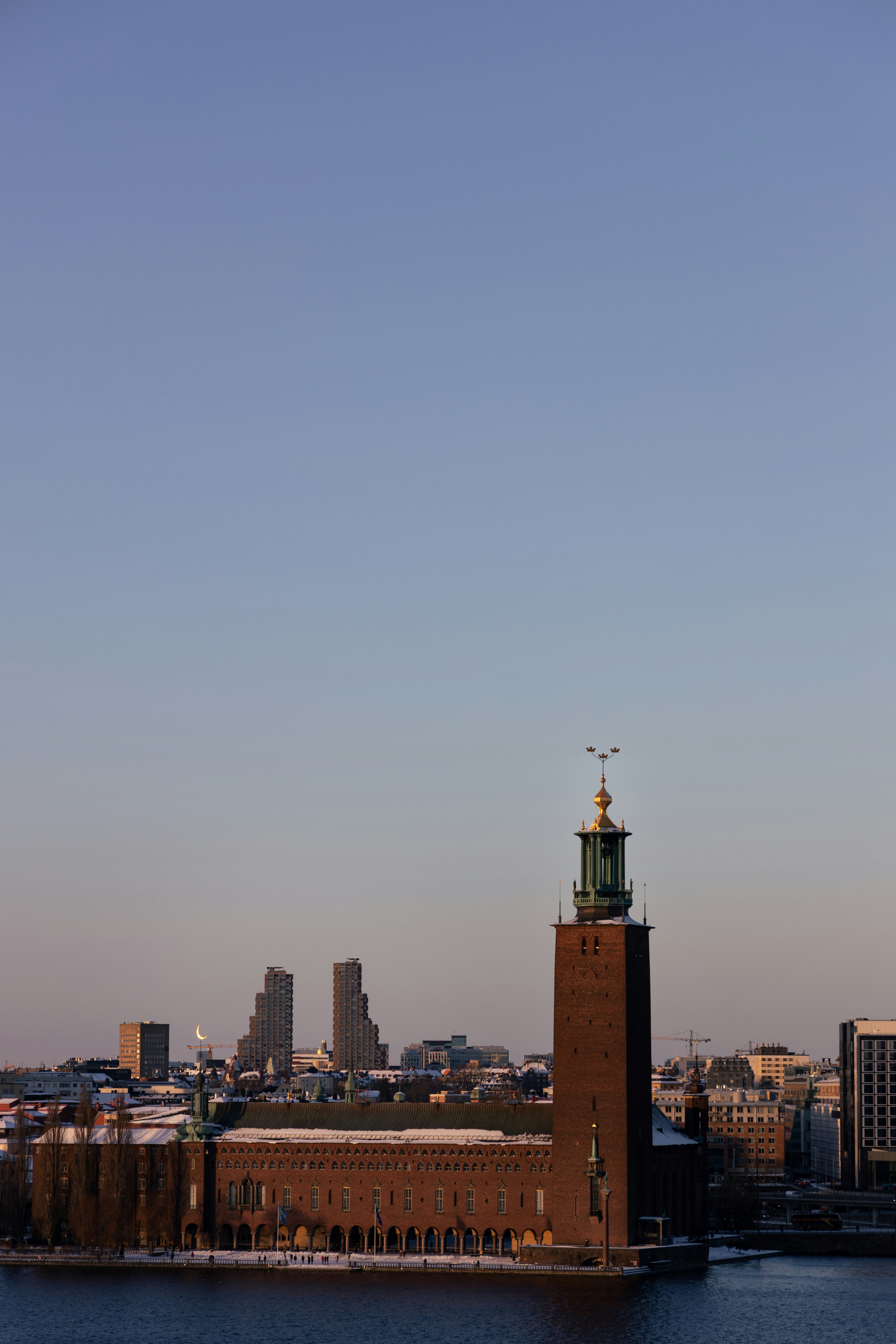 Harbor Sentinel: The Brick Tower Reaching Toward a Pale Dusk Sky