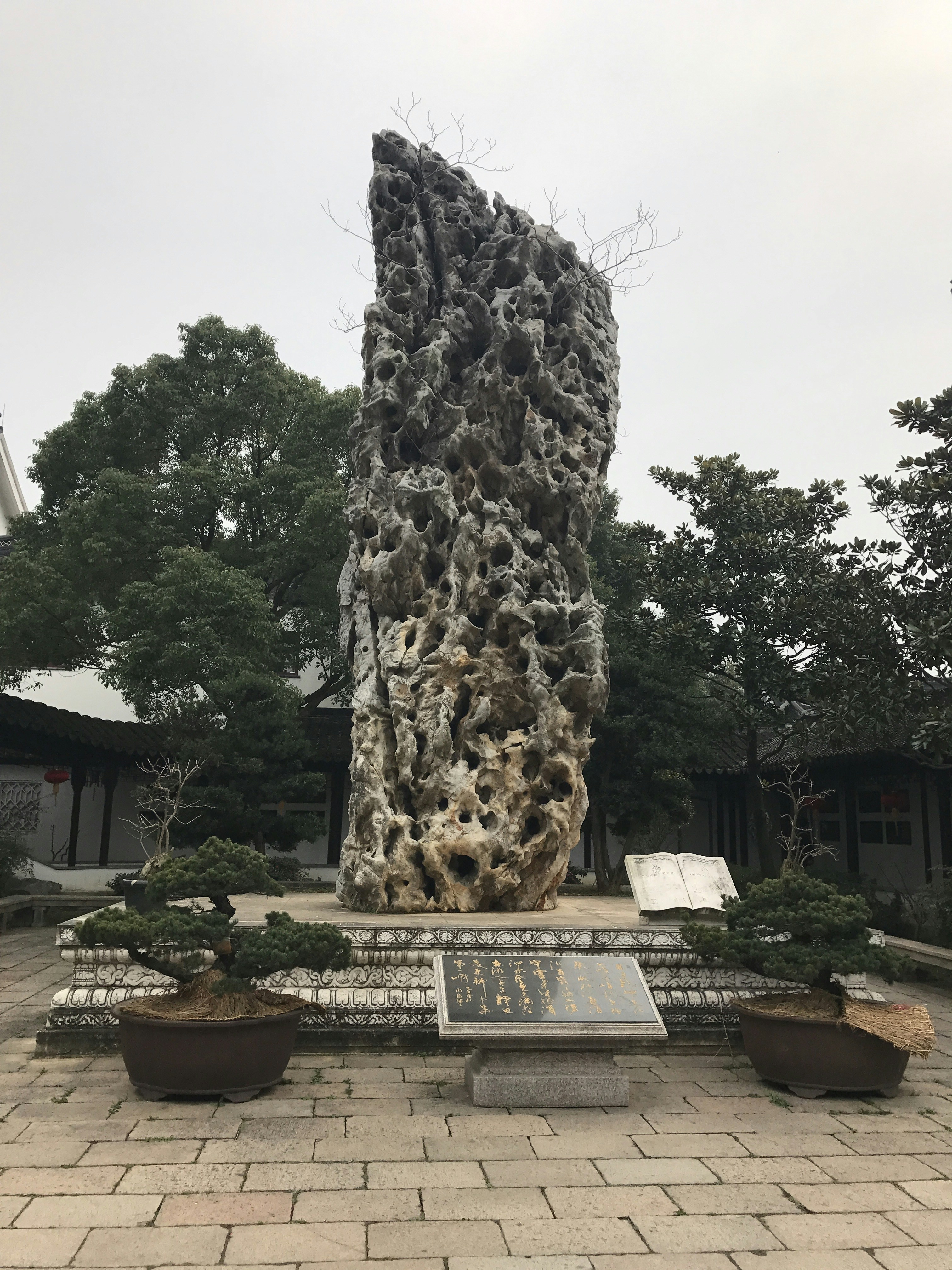 Weathered Stone Monolith Anchoring a Quiet Temple Courtyard