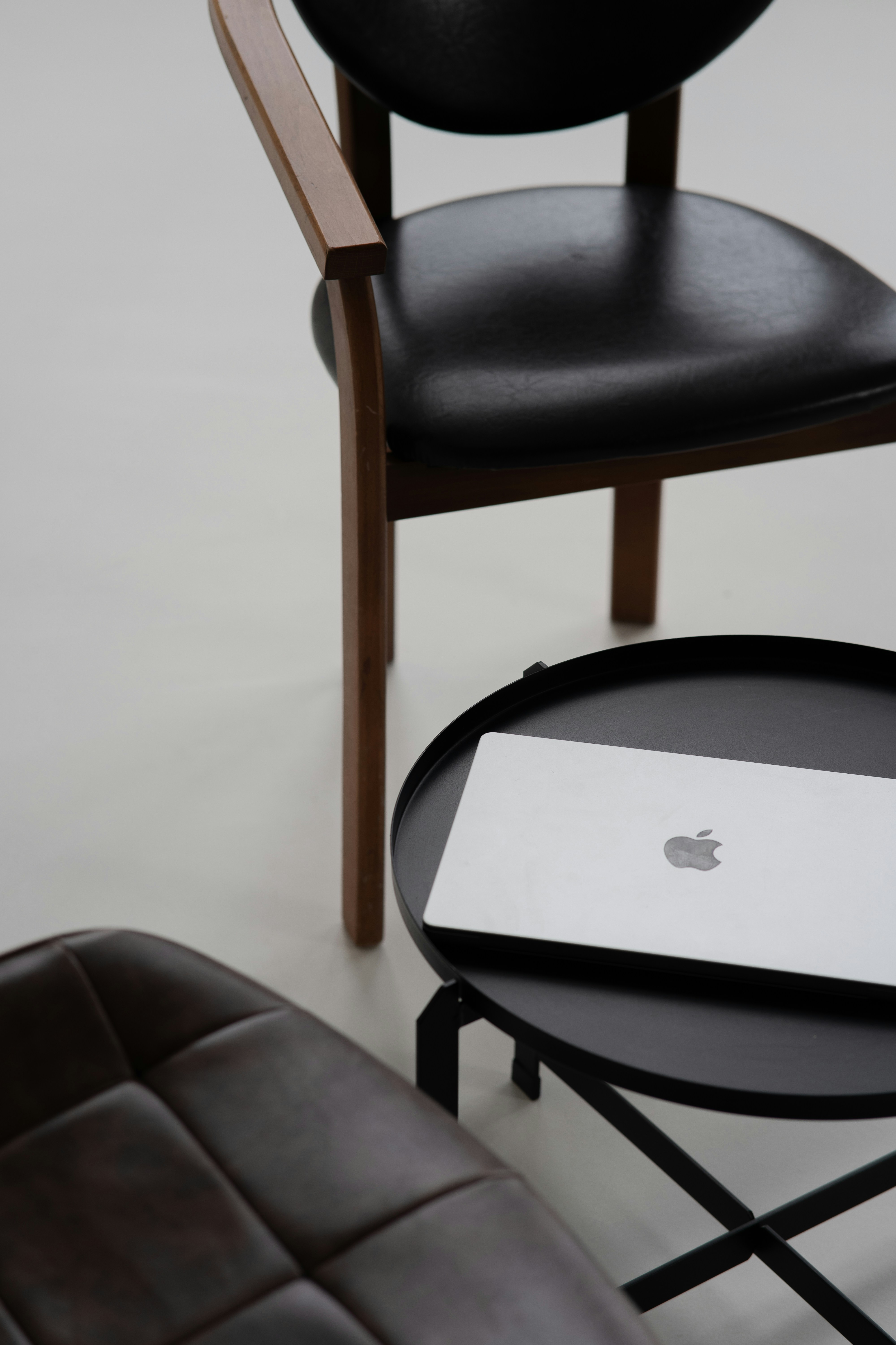 Minimalist living room vignette with Apple logo card on a round coffee table