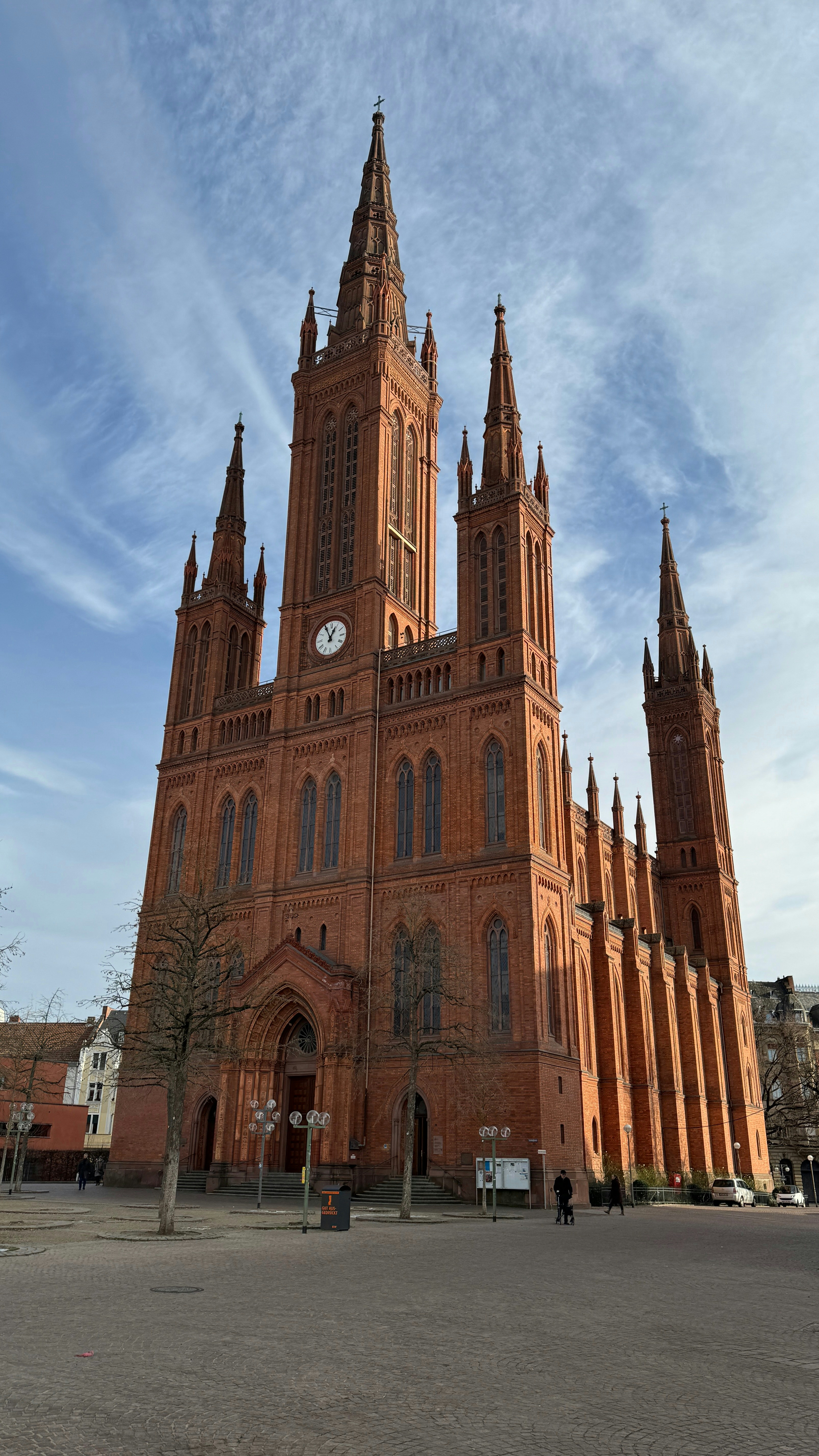 Neo-Gothic spire: a red-brick cathedral towering over a cobbled plaza