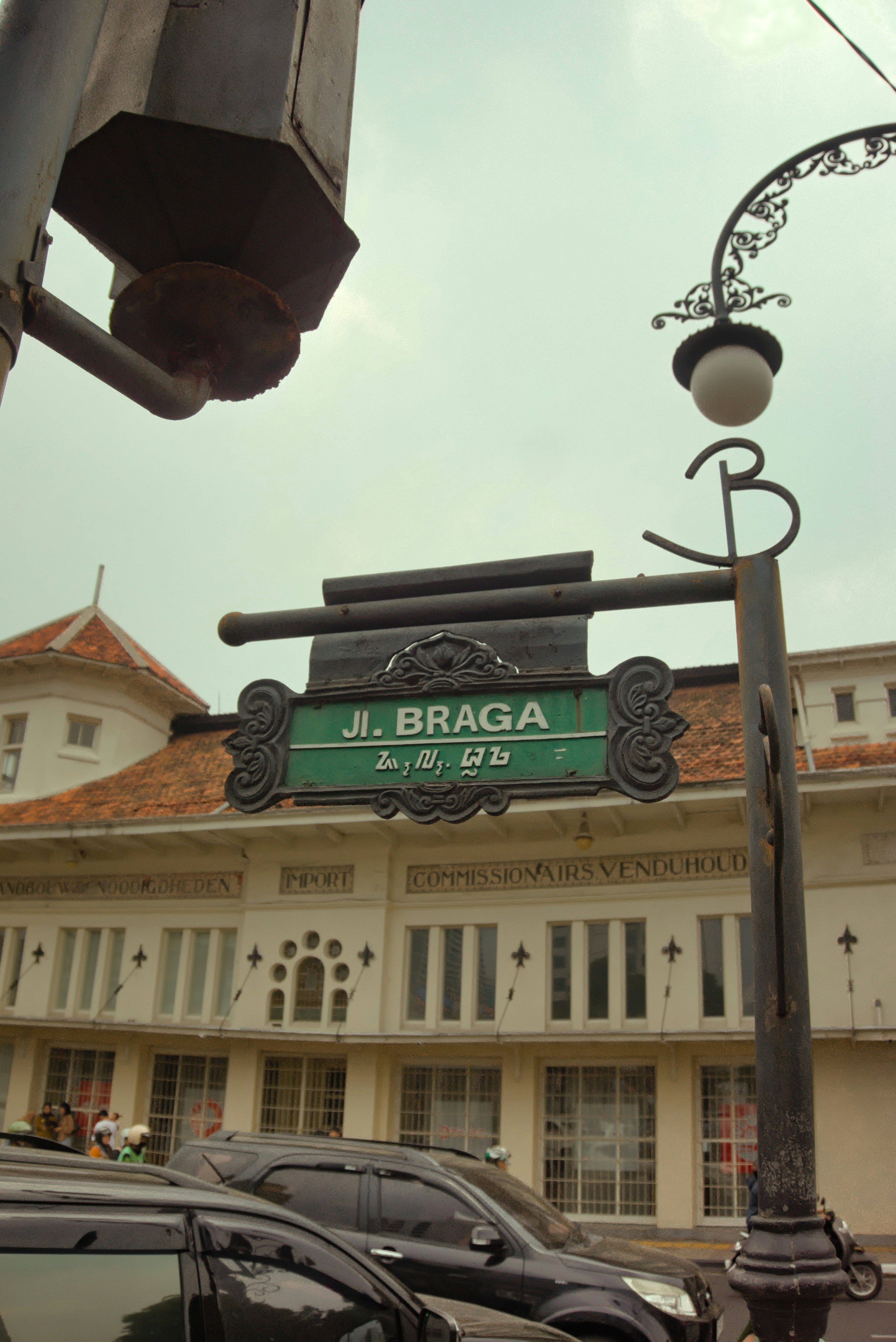 J. Braga Sign Framed by an Ornate Streetlamp Over a Colonial Street