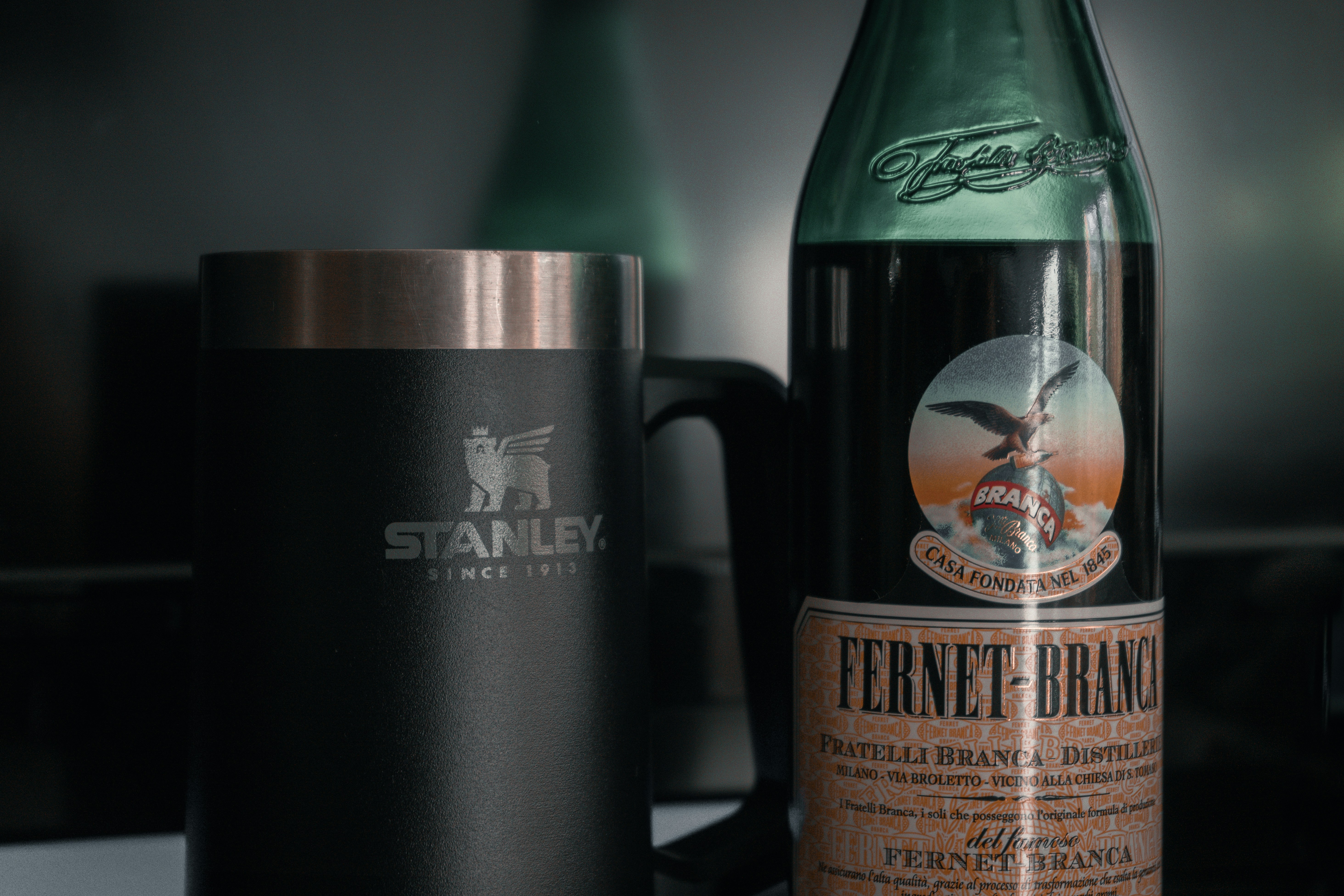 Amber Quiet: Fernet-Branca and a Matte Stanley in Low-Key Still Life
