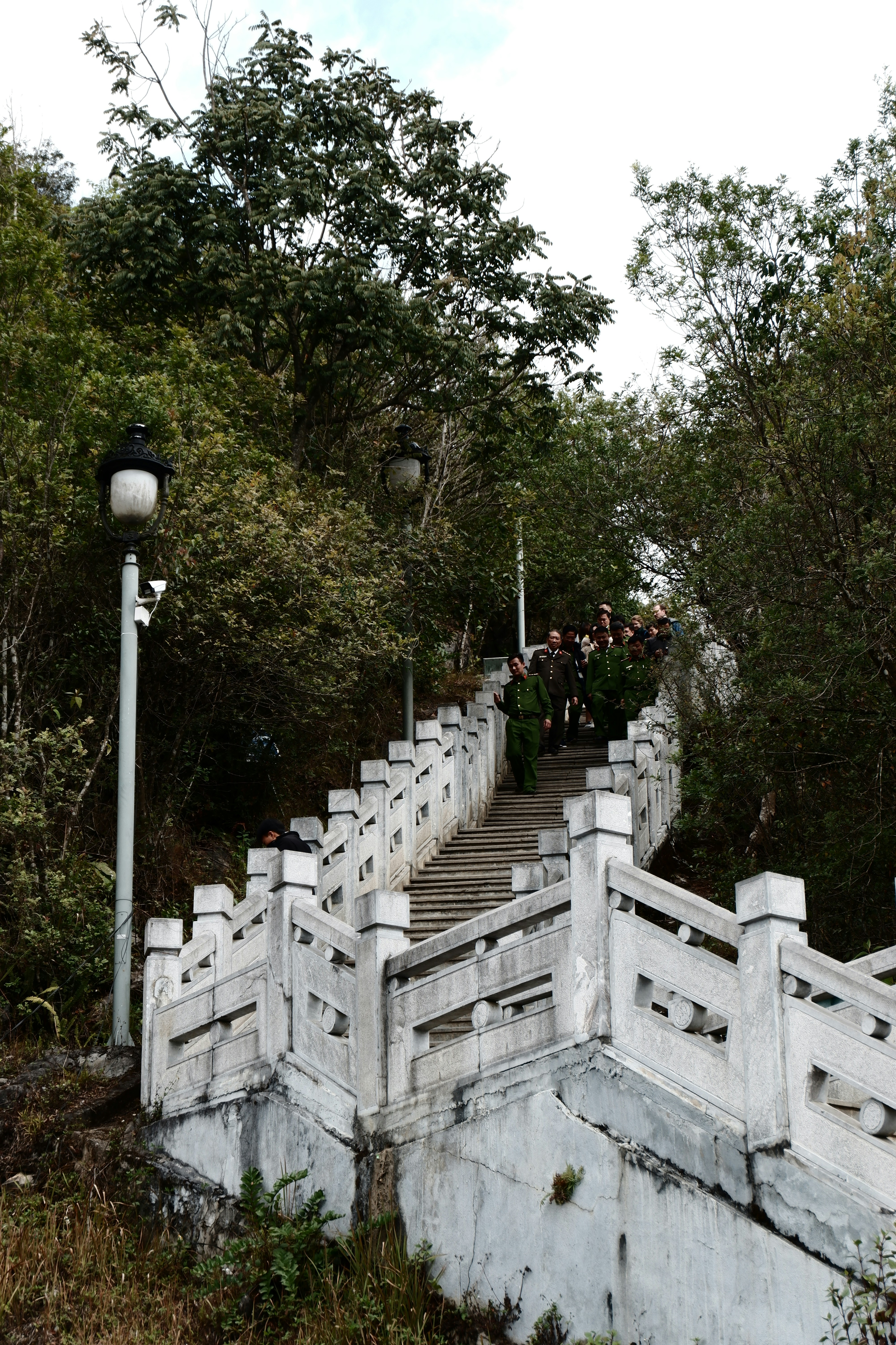 Ascending Vigil: Uniformed Figures on a White Stone Staircase