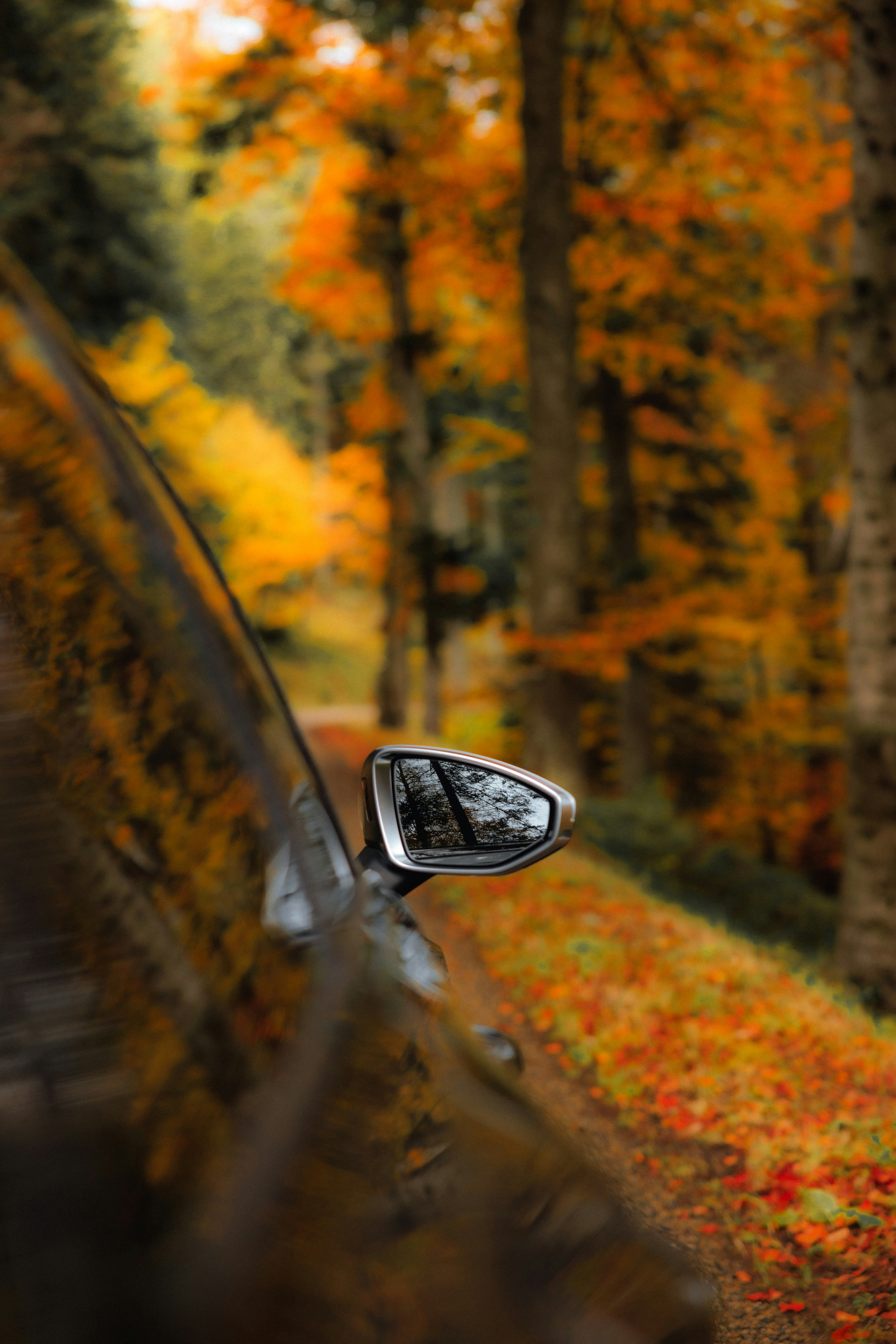 A car parked on the side of a road in the fall photo – Free Car Image ...