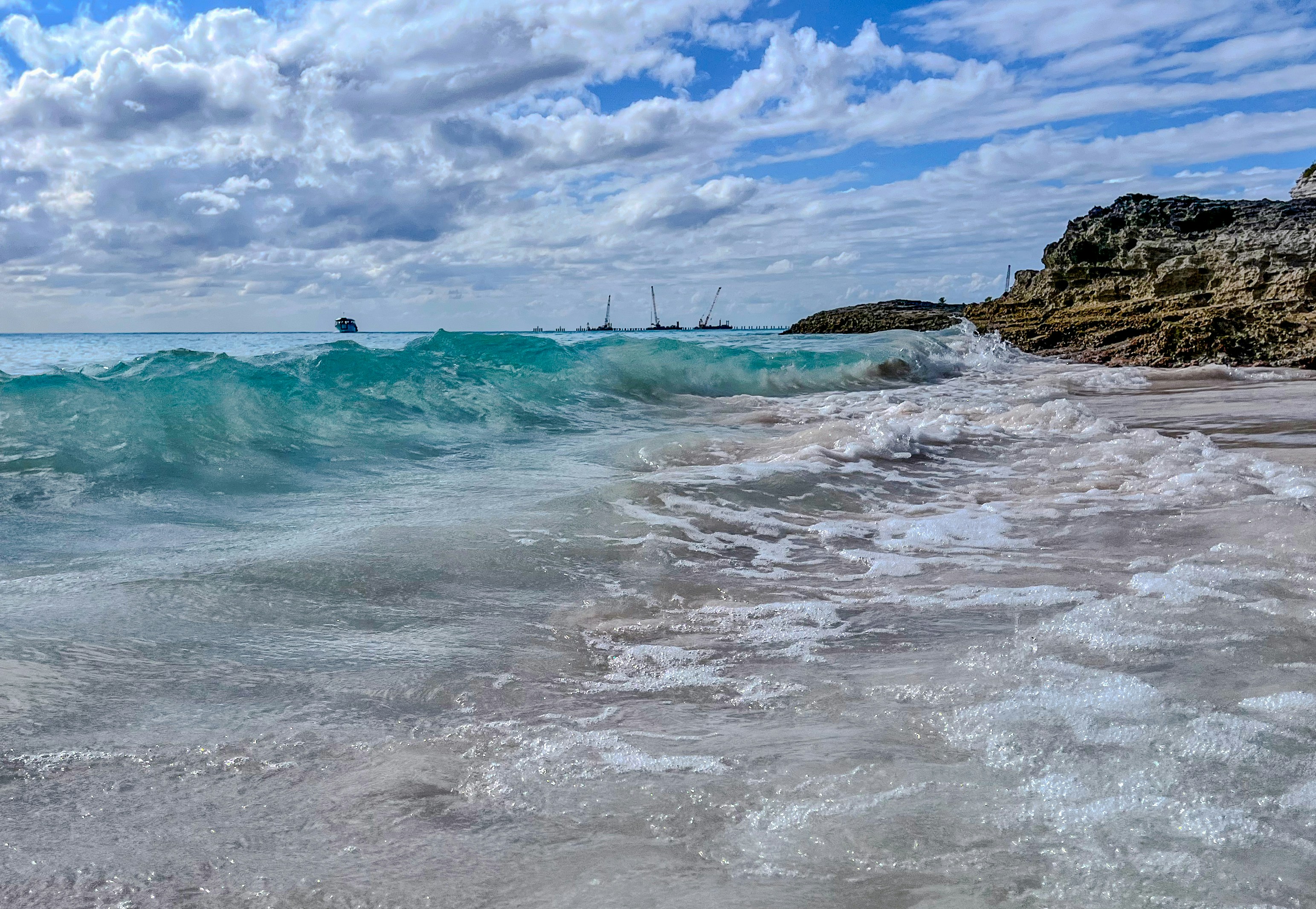 A beach with waves coming in and out of the water photo – Free Sea ...