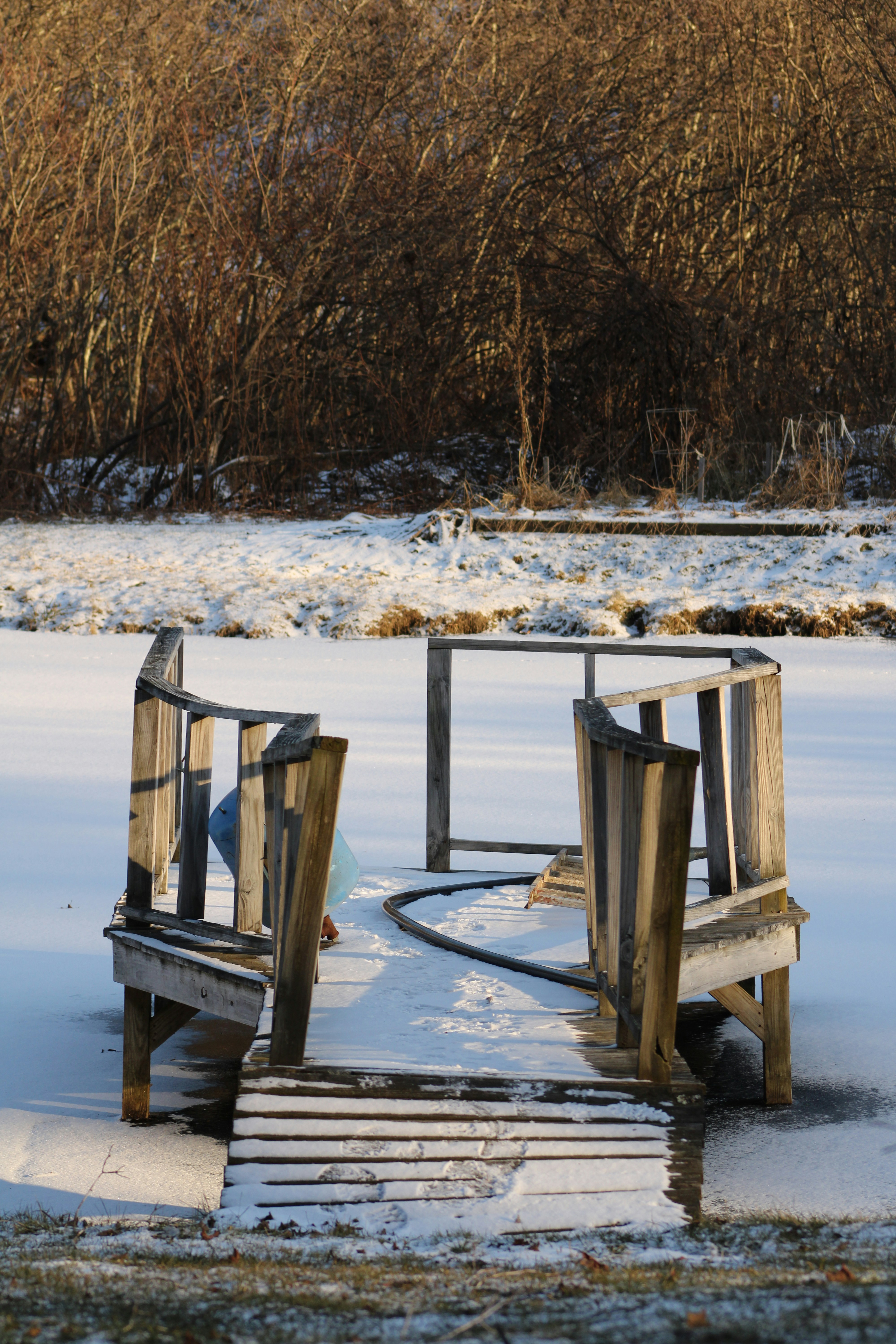 Frozen Pier Reaches Across a Quiet Snow-Glazed Lake