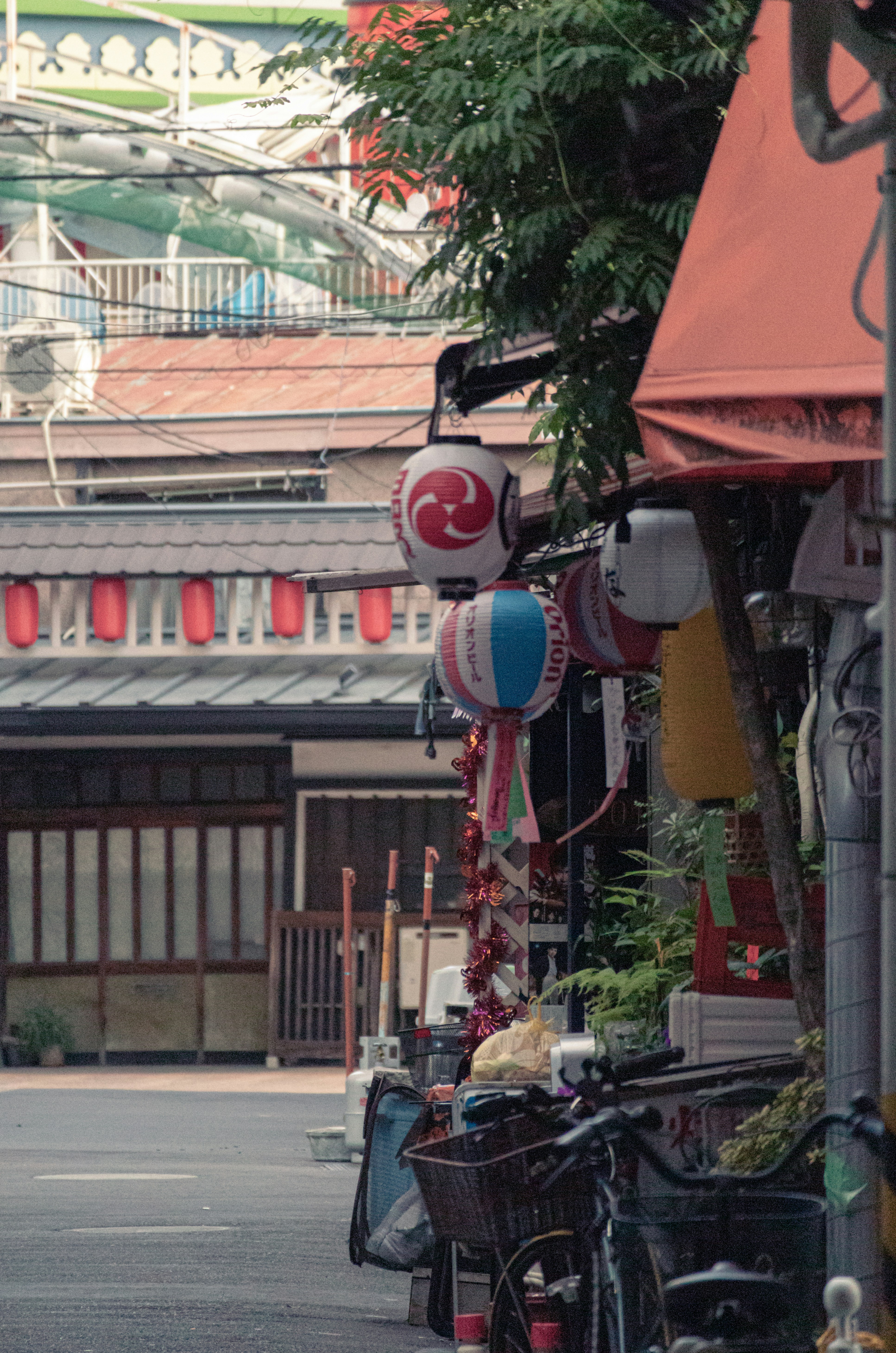Red Lanterns and Quiet Motion: An Alley of Bicycles and Shopfronts