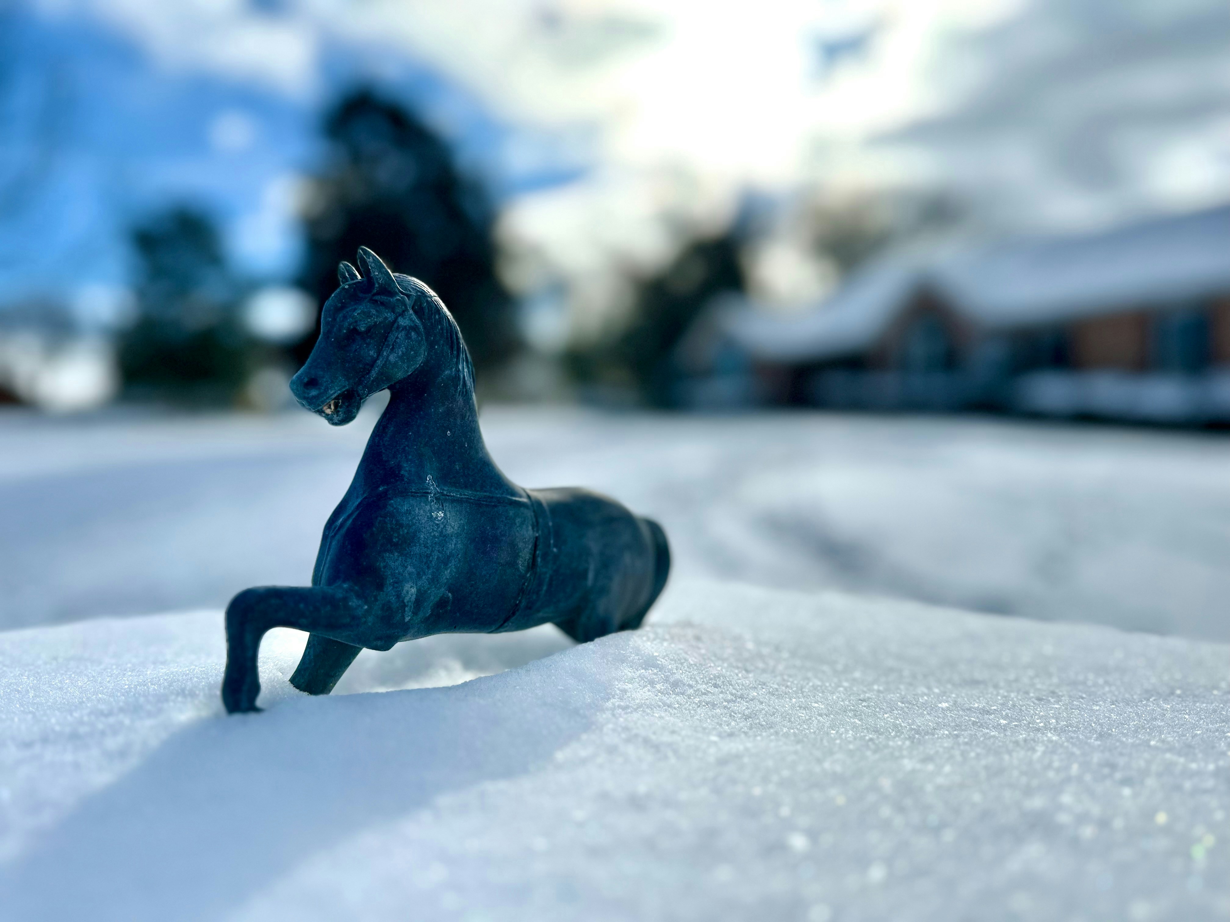 Snowbound Stallion: A Bronze Horse Brass Peers Above a Frosted Drift