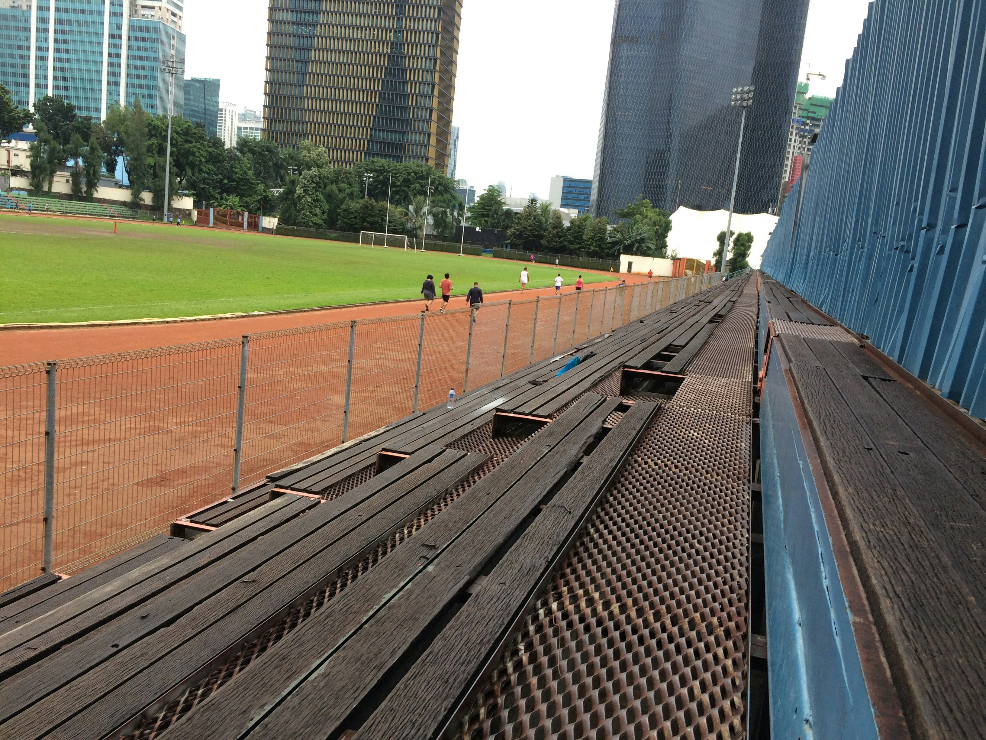 Ridge Lines: Wooden Bleachers Stretch Beside a Skyward City