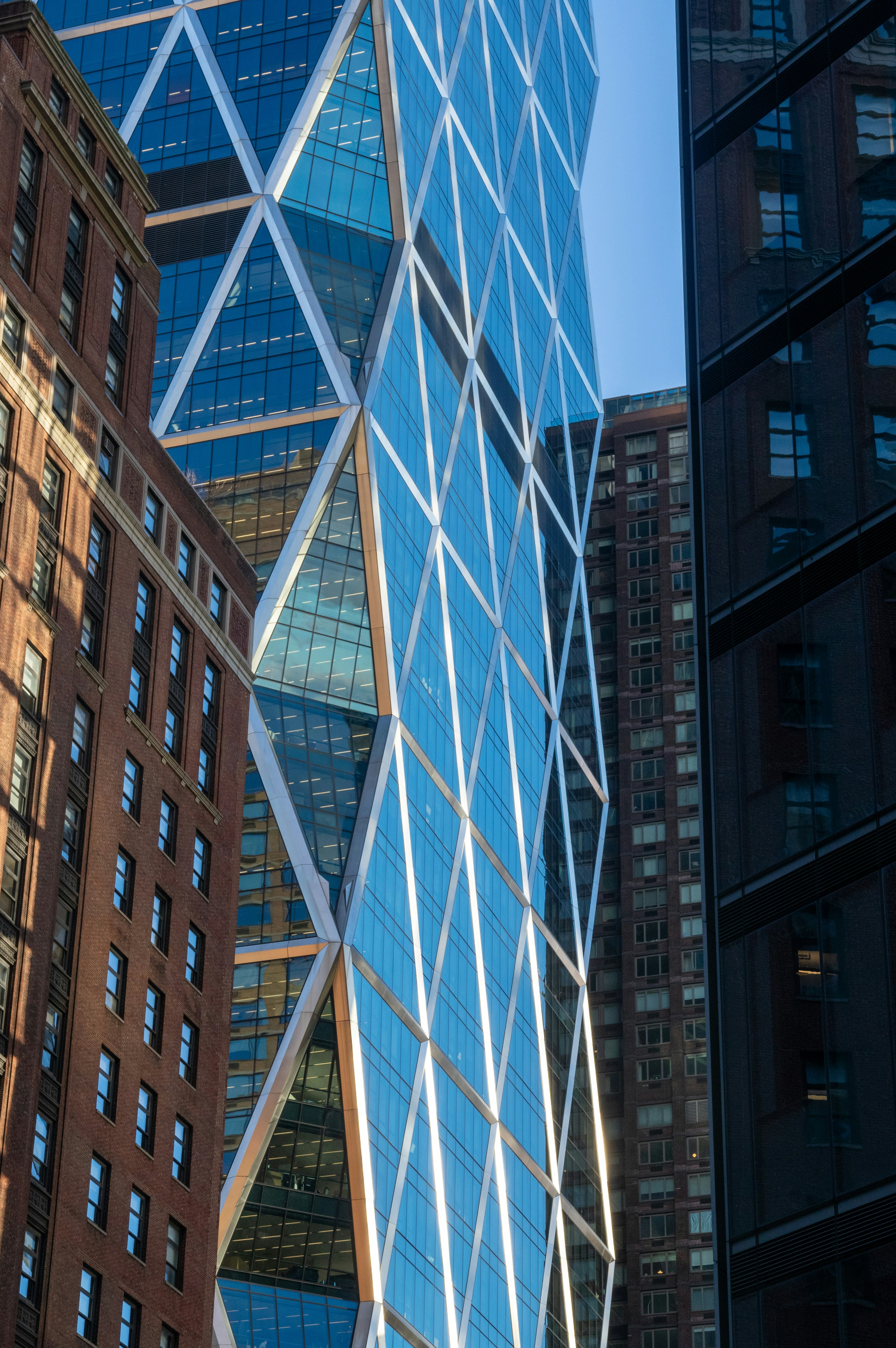 Diamond Facade: Blue Glass Diagonals Against Urban Brick