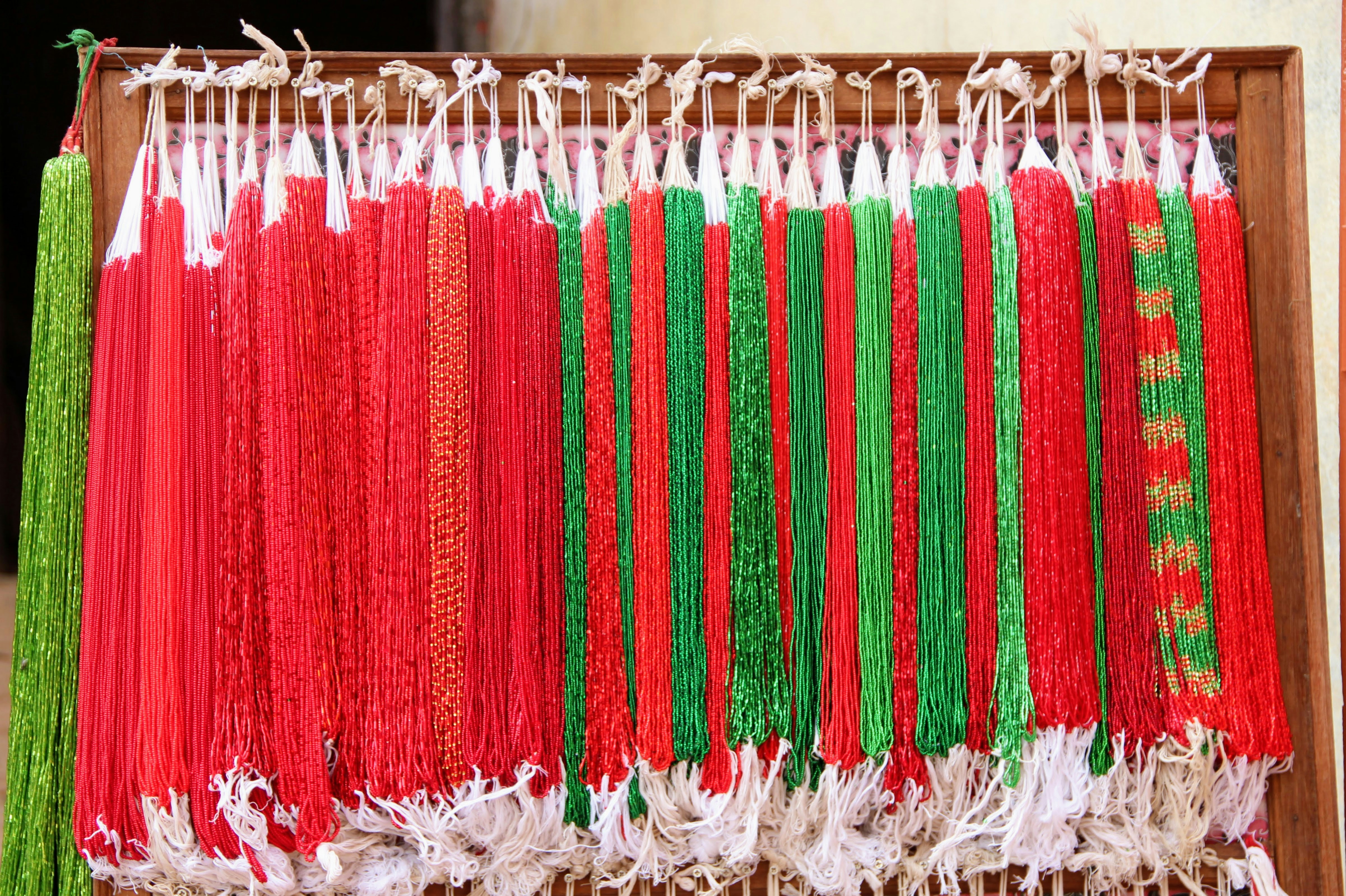 A close up of a bunch of red and green string photo – Free Nepal Image ...