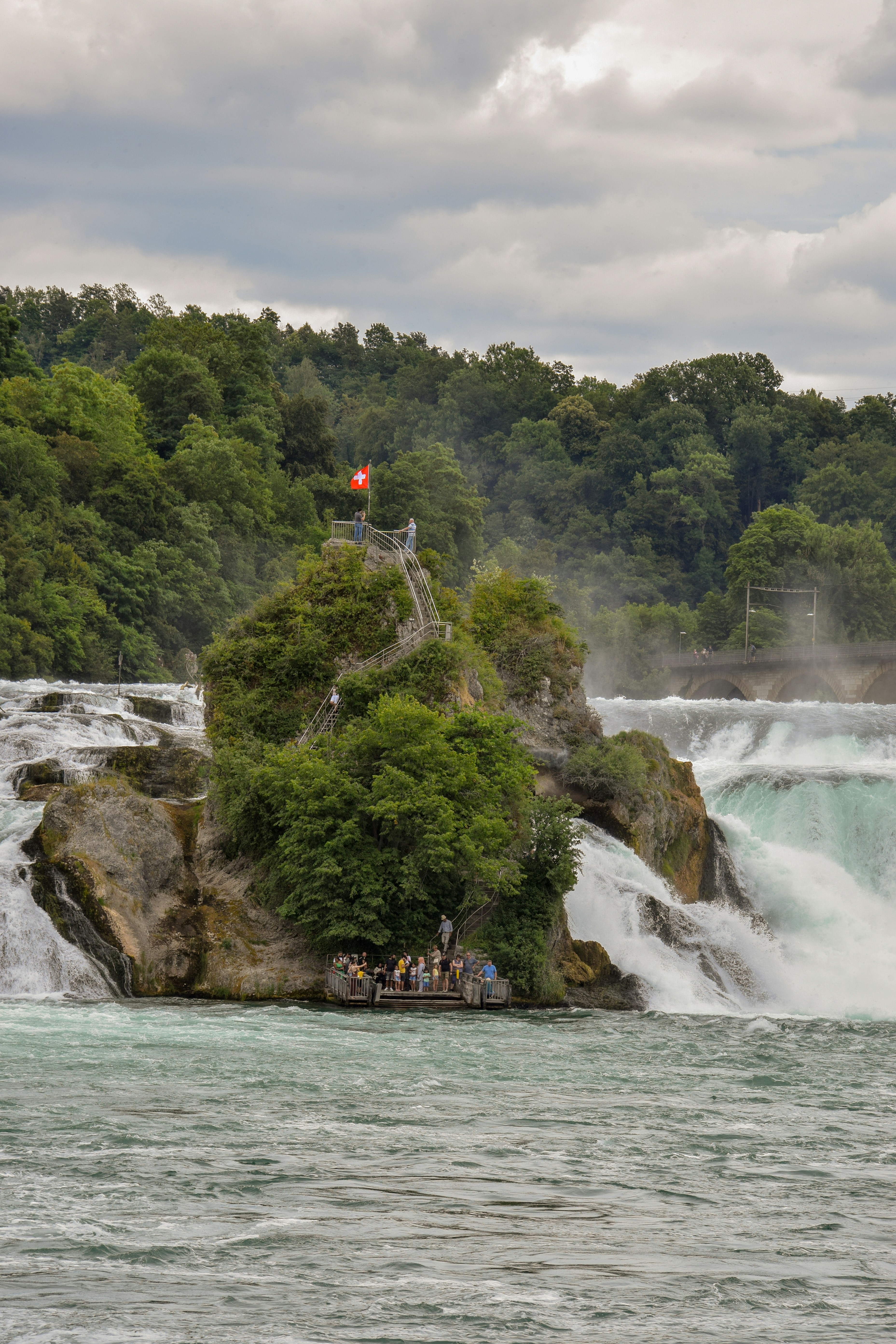 A group of people standing on top of a waterfall photo – Free ...