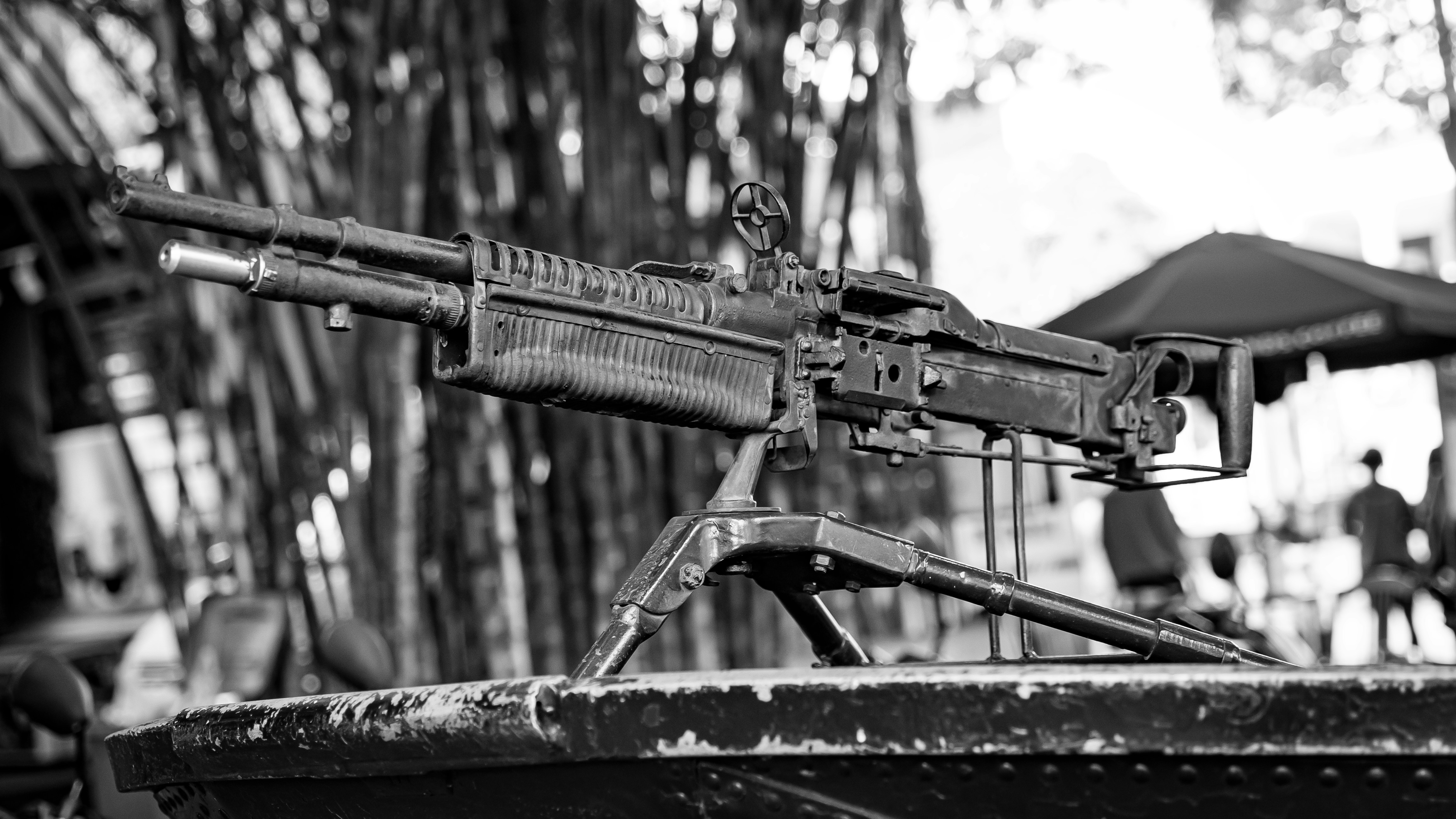 A machine gun sitting on top of a wooden table photo – Free Gun Image ...