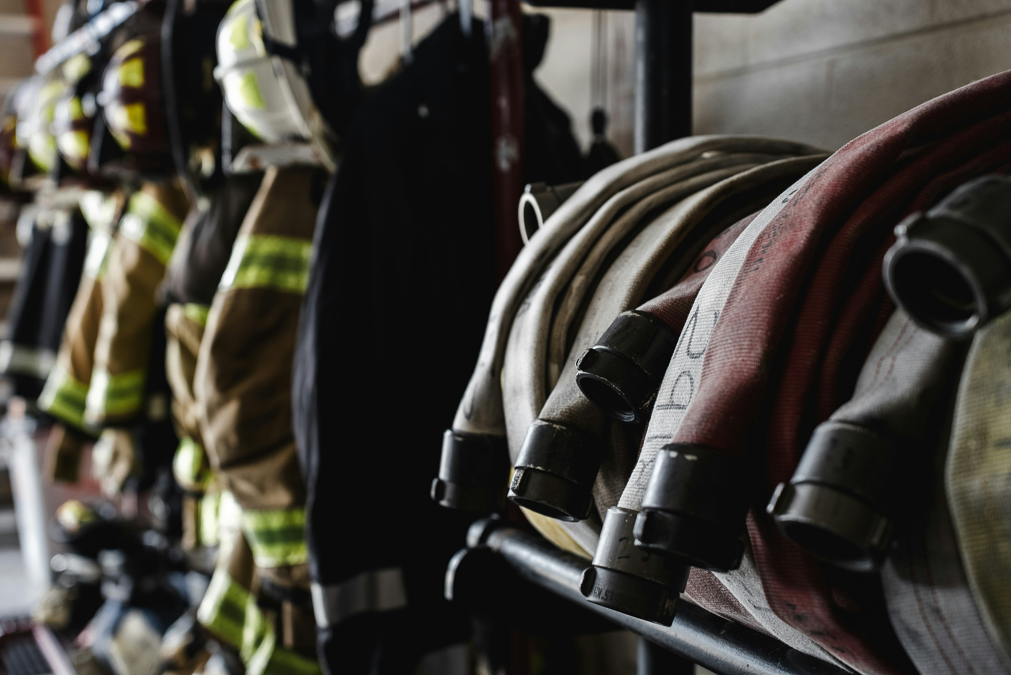 A row of fire hoses hanging on a wall photo – Free Black Image on Unsplash