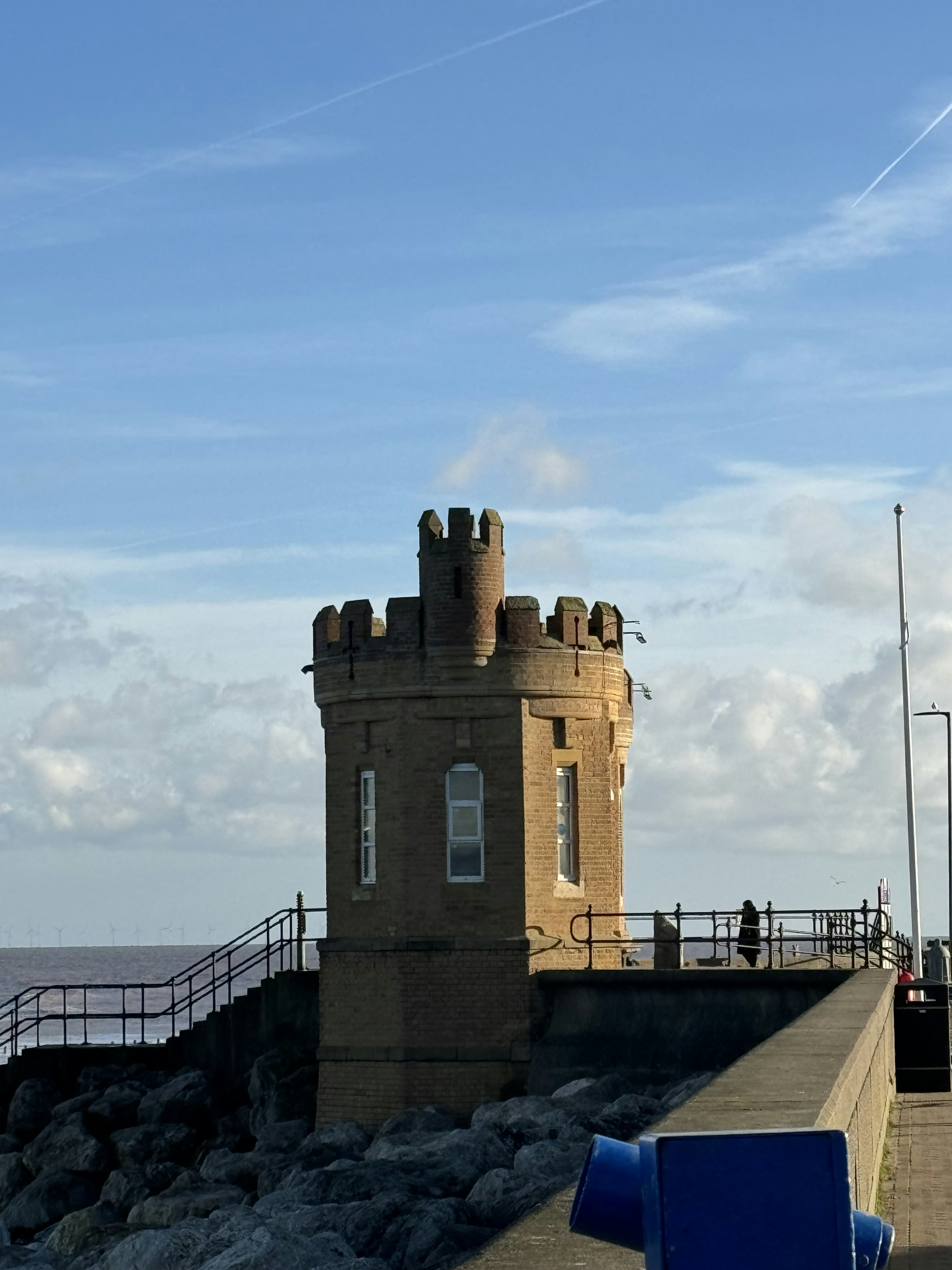 Castle on the Pier: A Brick Turret Gazes Over the Sea