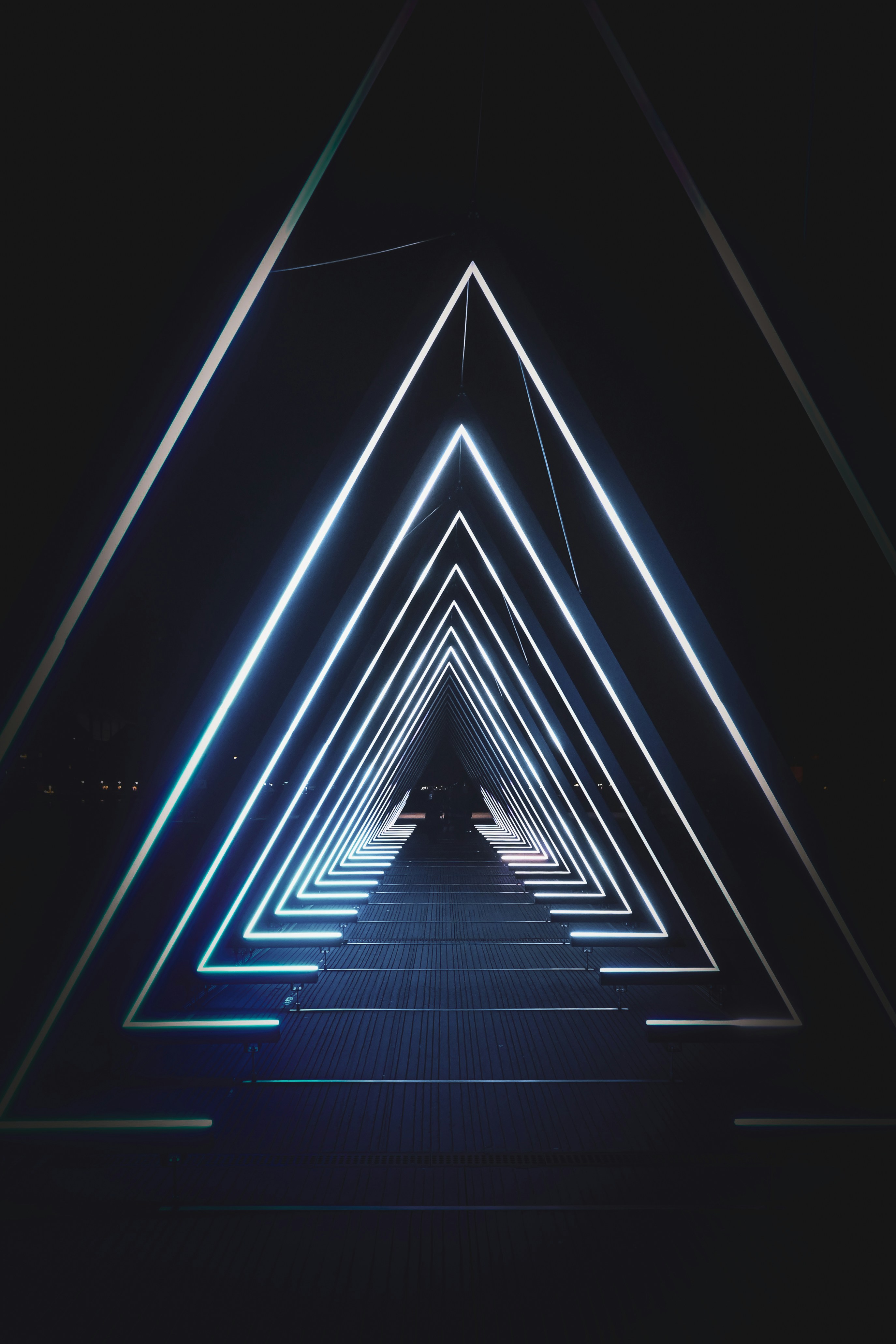 A very dark room with a very long line of lights photo – Free ...