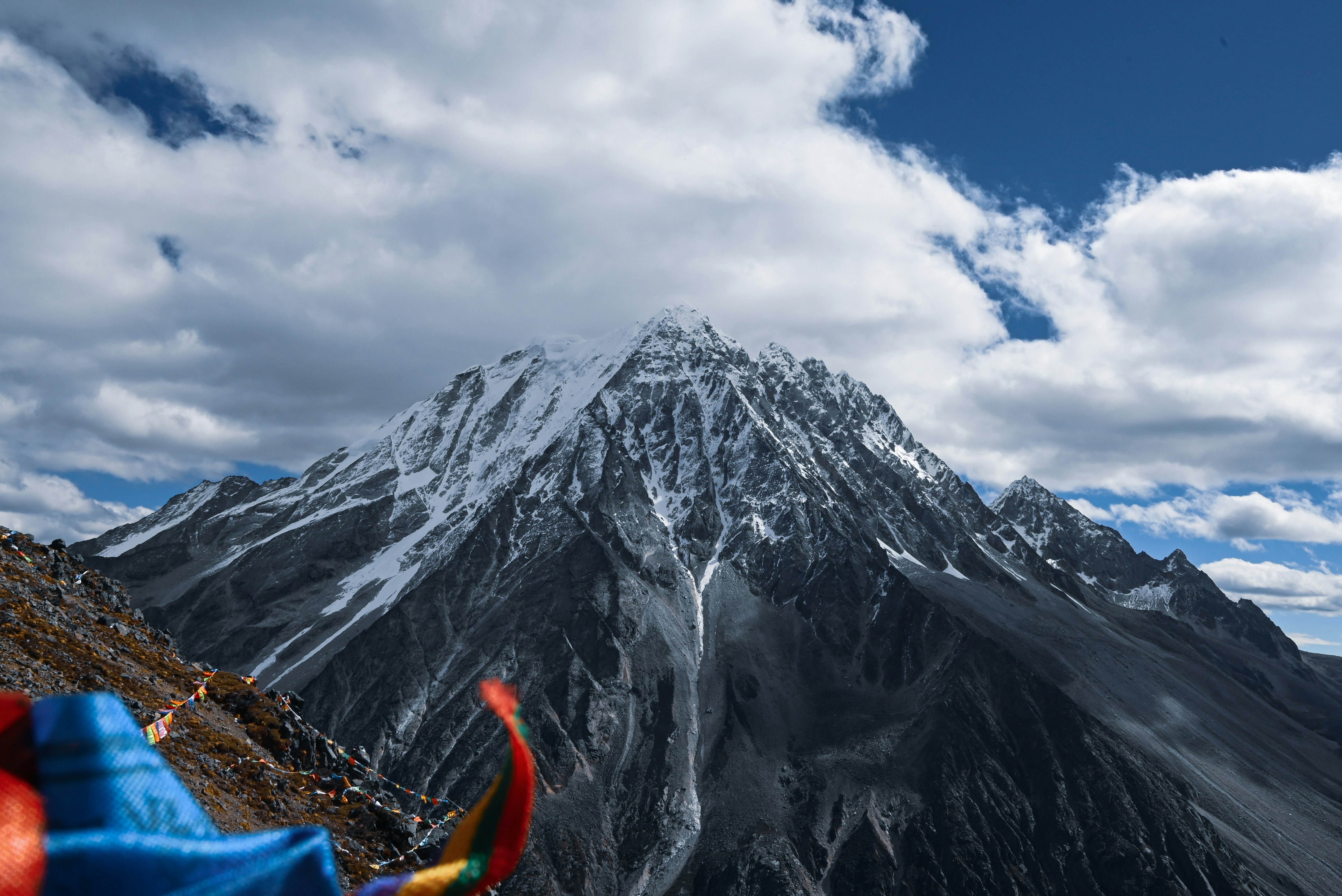 Snow-Crowned Peak Under a Break in Clouds