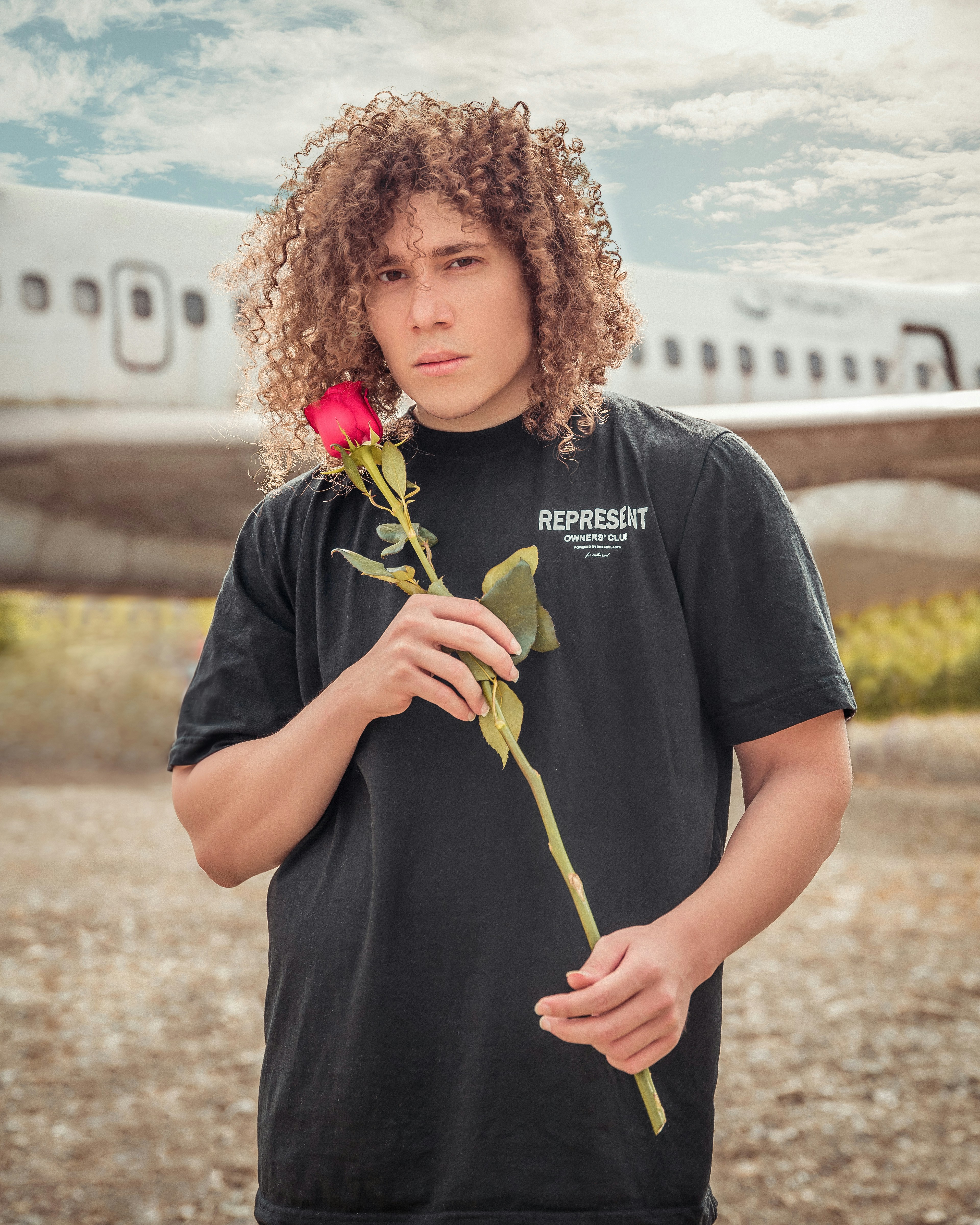 Red Rose, Quiet Defiance: A Portrait by the Runway of Rails