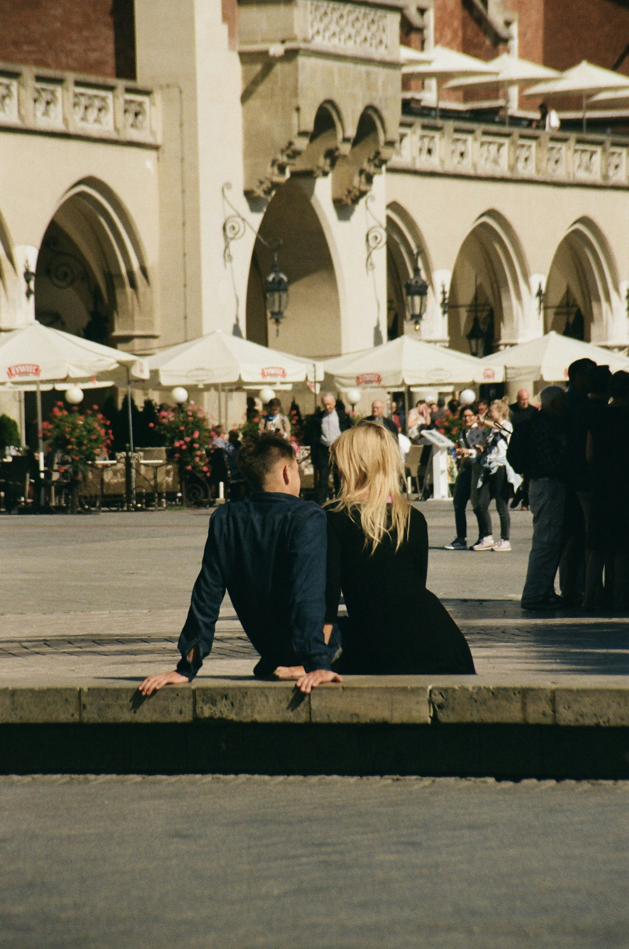 Couple at the Edge of the Piazza, Autumn Light on a City Stage