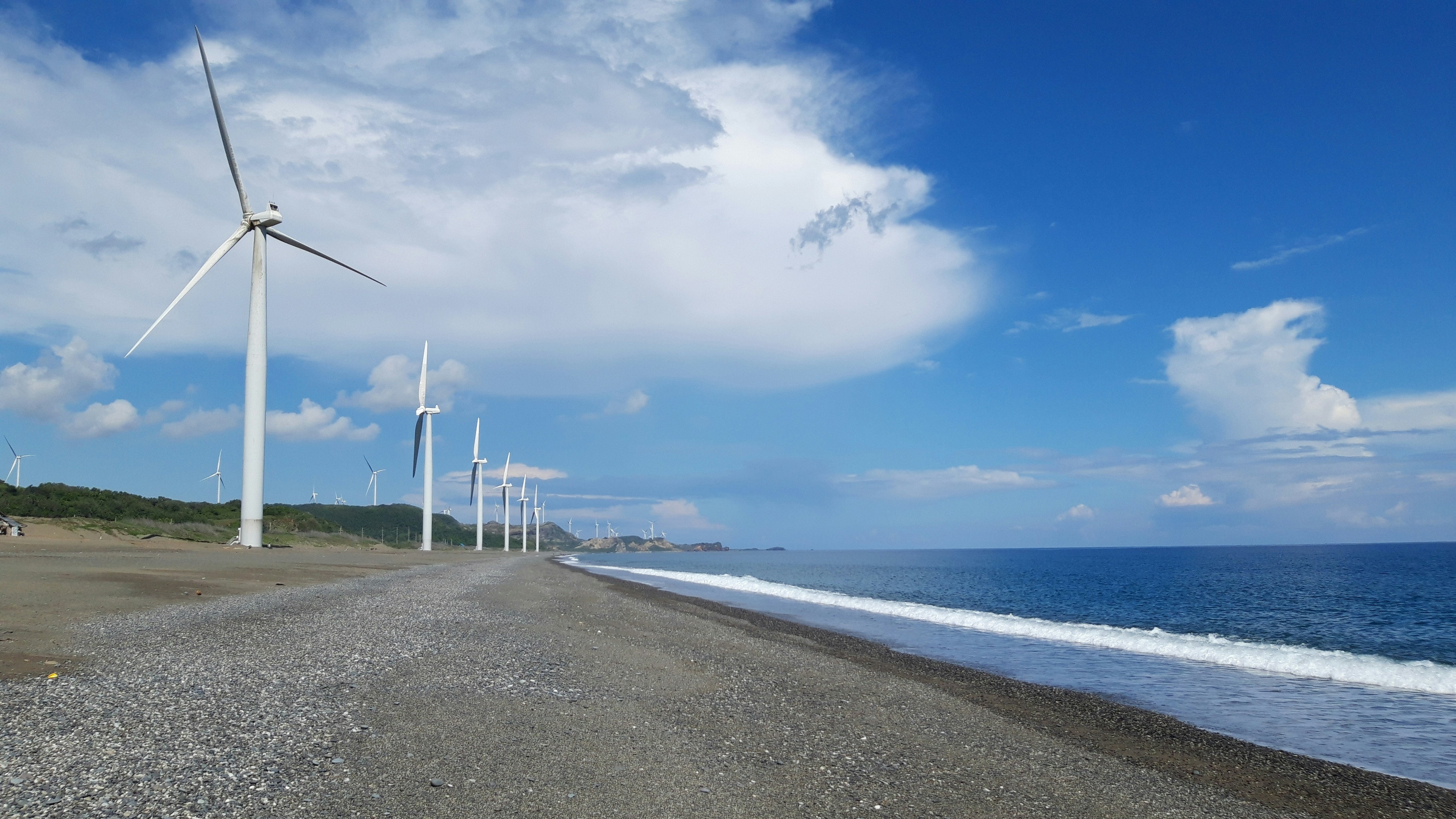 Embark on a visual journey with the captivating allure of the Windmills of Ilocos Norte standing proudly by the serene beach.