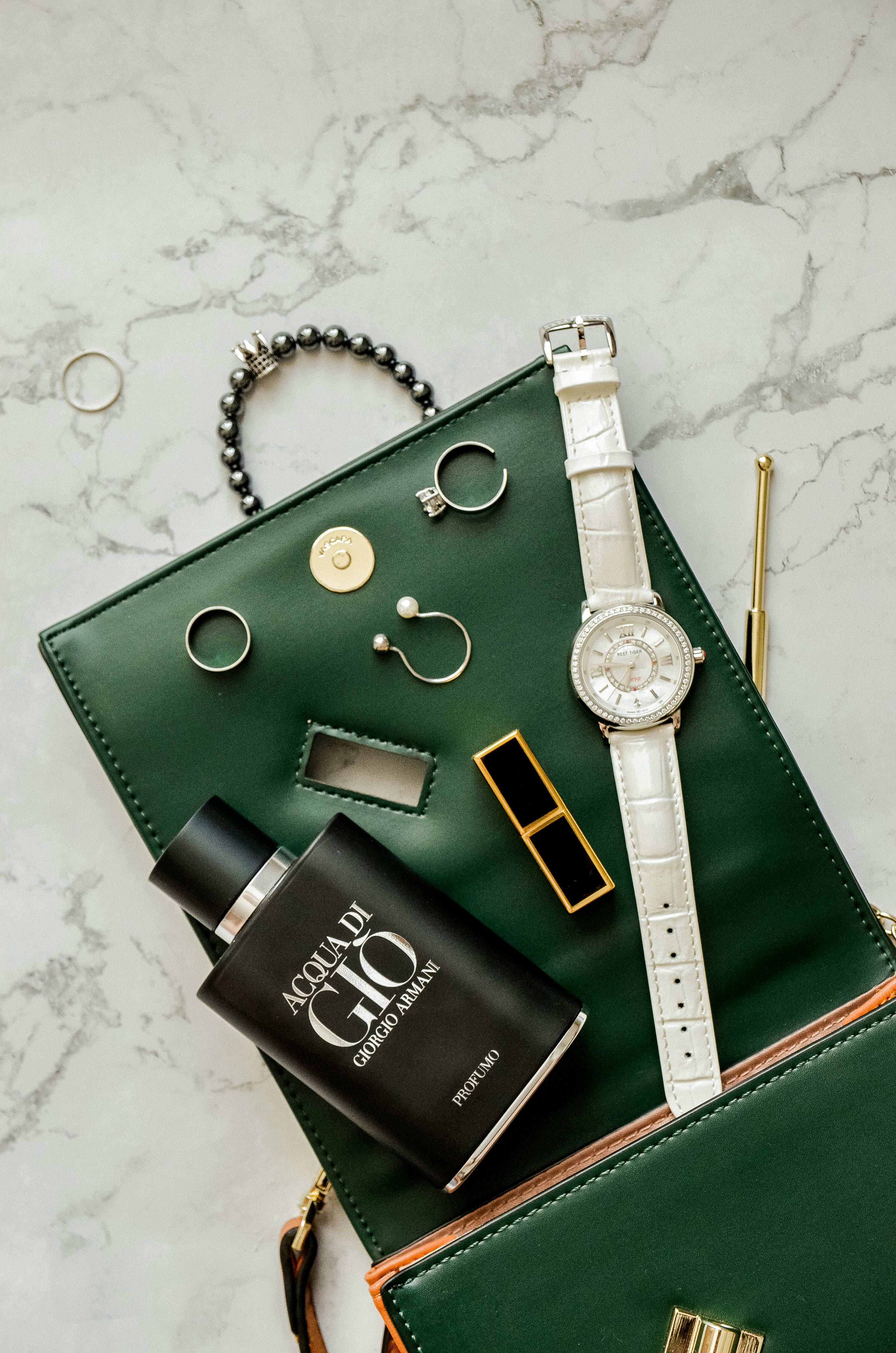 Marble Studio of Green Leather, Silver Jewelry, and a White-Wristwatch