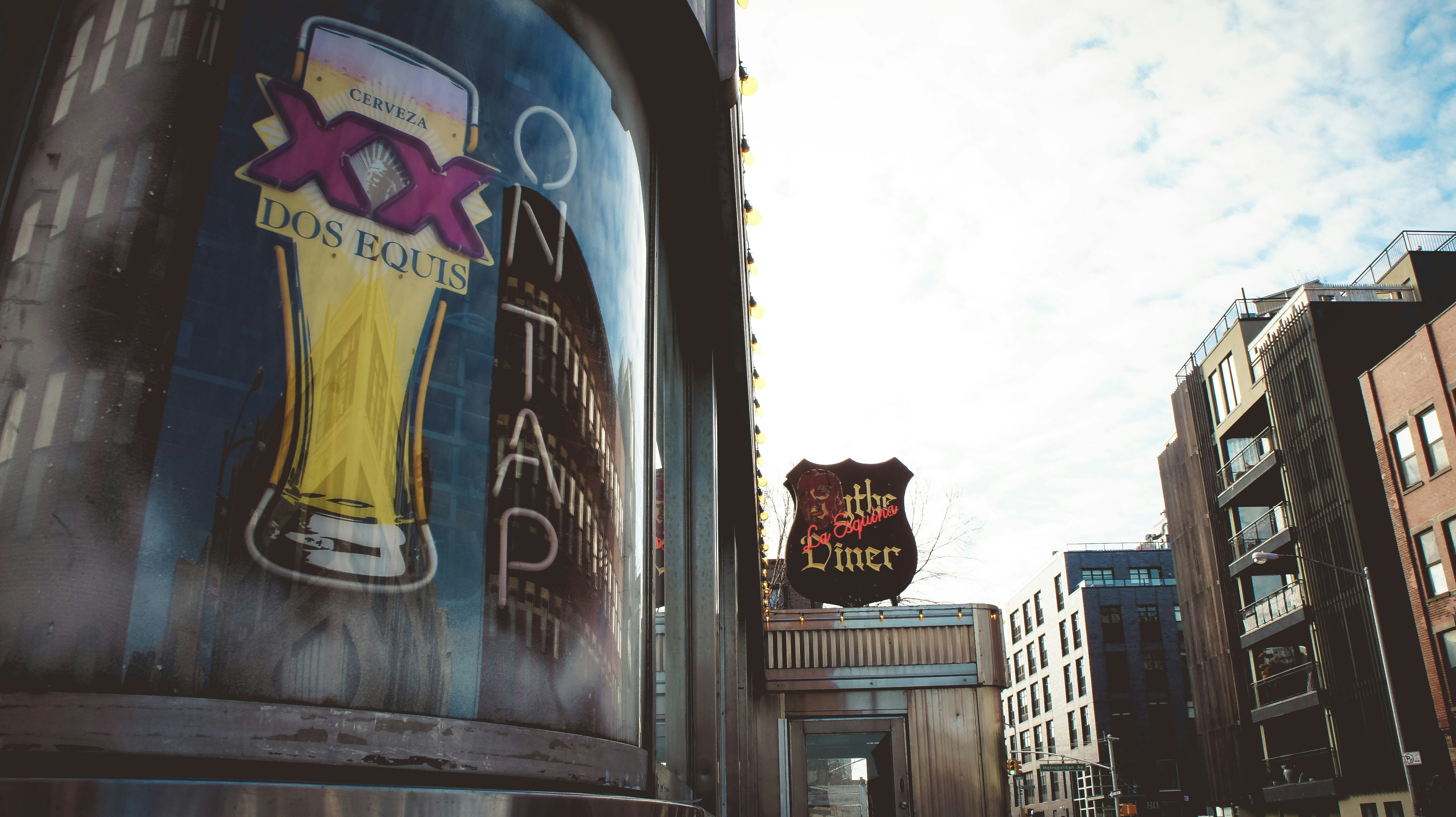 A beer sign on a building in a city photo – Free Street Image on Unsplash