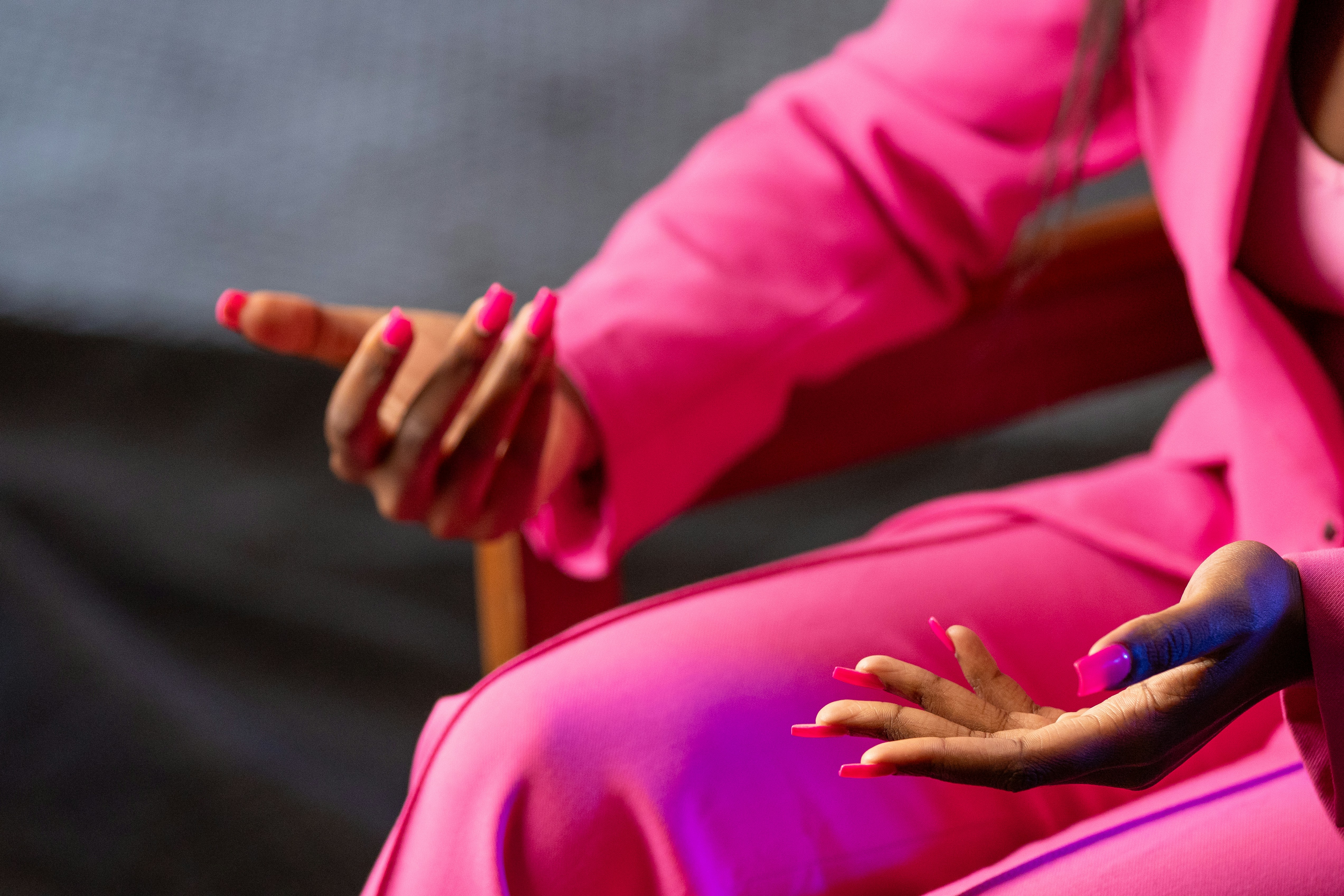 Vivid Hands: Neon Pink Ensemble in Quiet Gesture