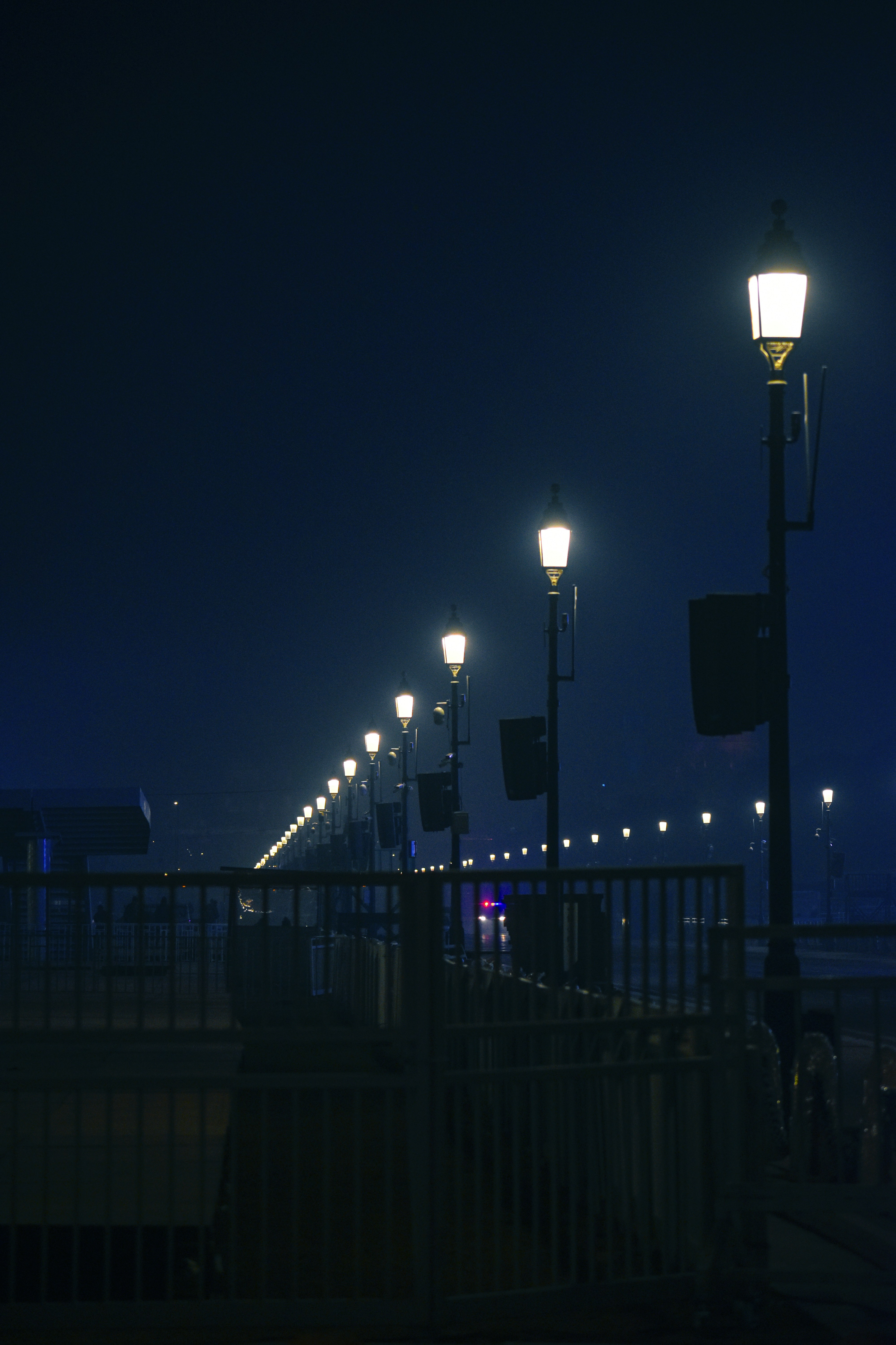 A row of street lights on a bridge at night photo – Free Delhi Image on ...