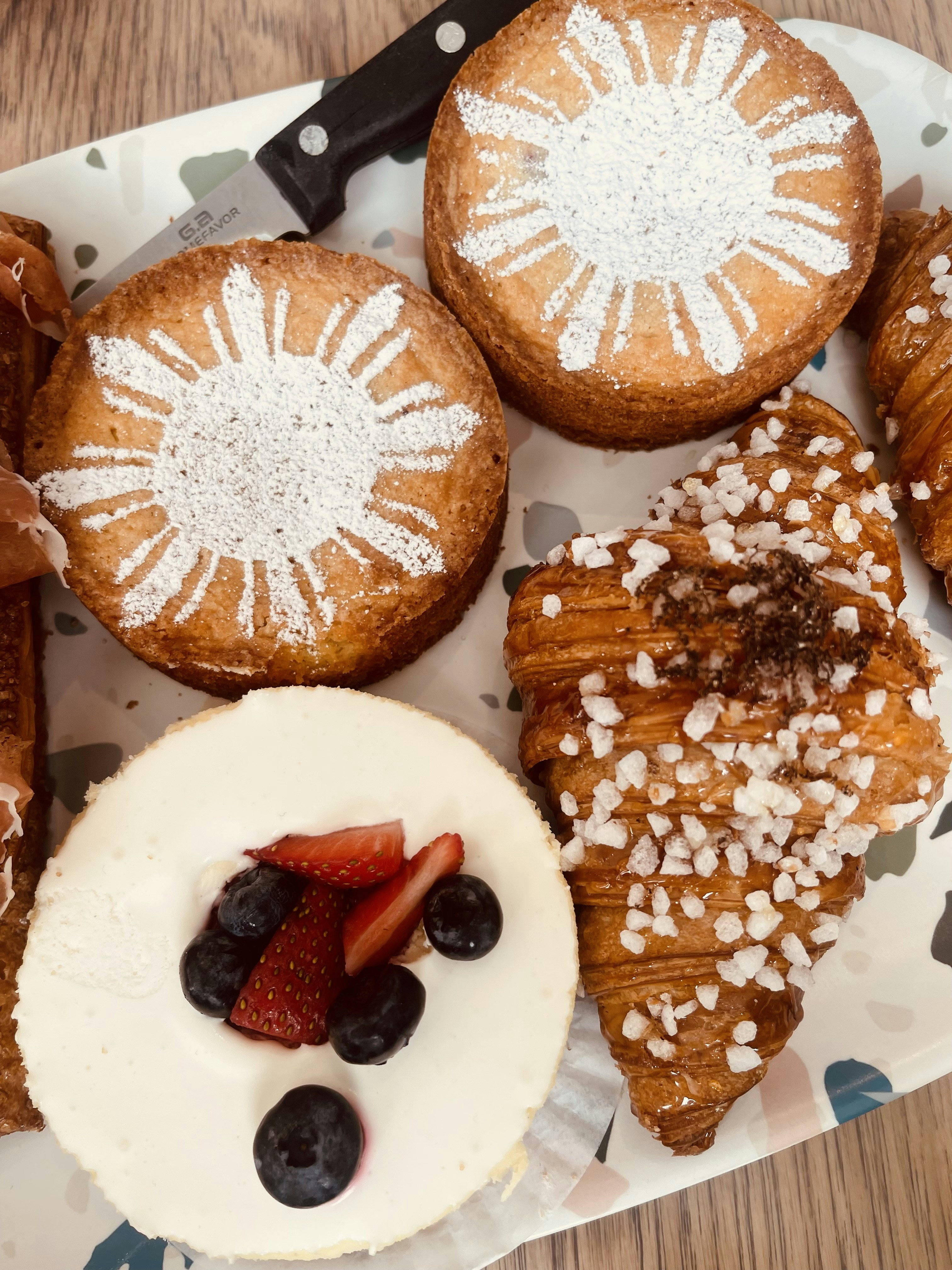 A white plate topped with pastries covered in powdered sugar photo ...