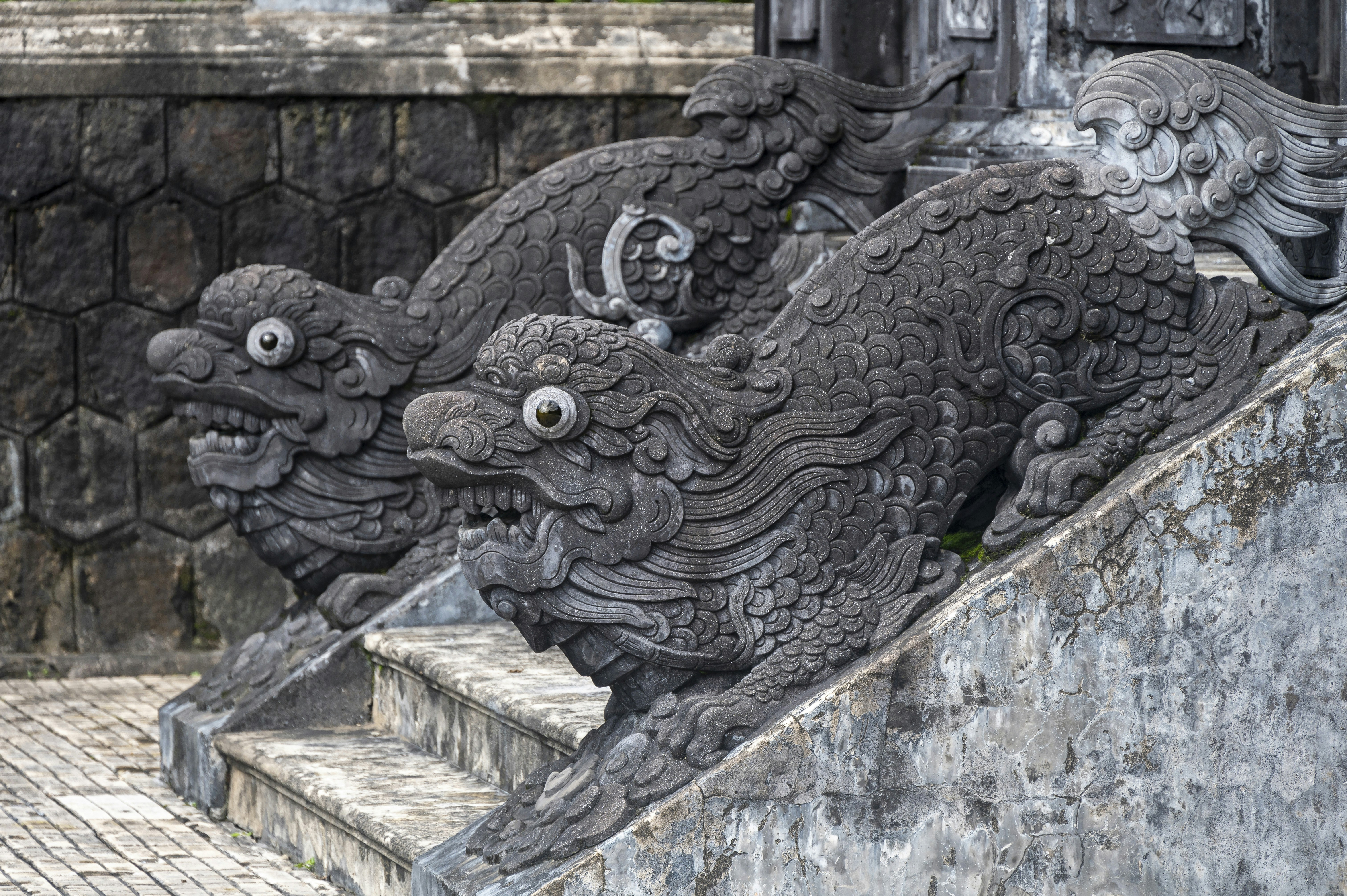 Guardians of the Stair: Weathered Stone Dragons in Row