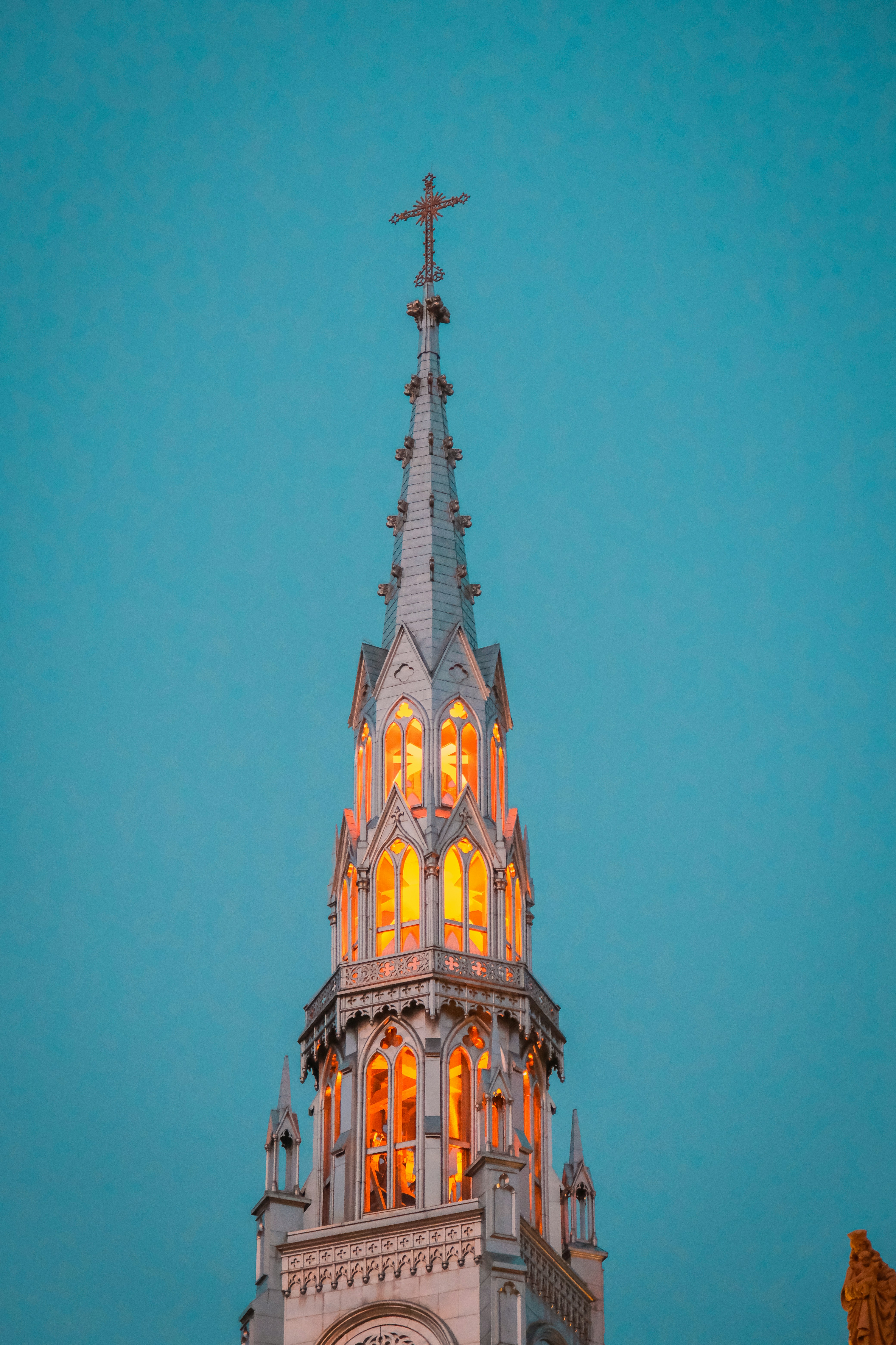 Amber-lit Spire Piercing a Quiet Blue Evening