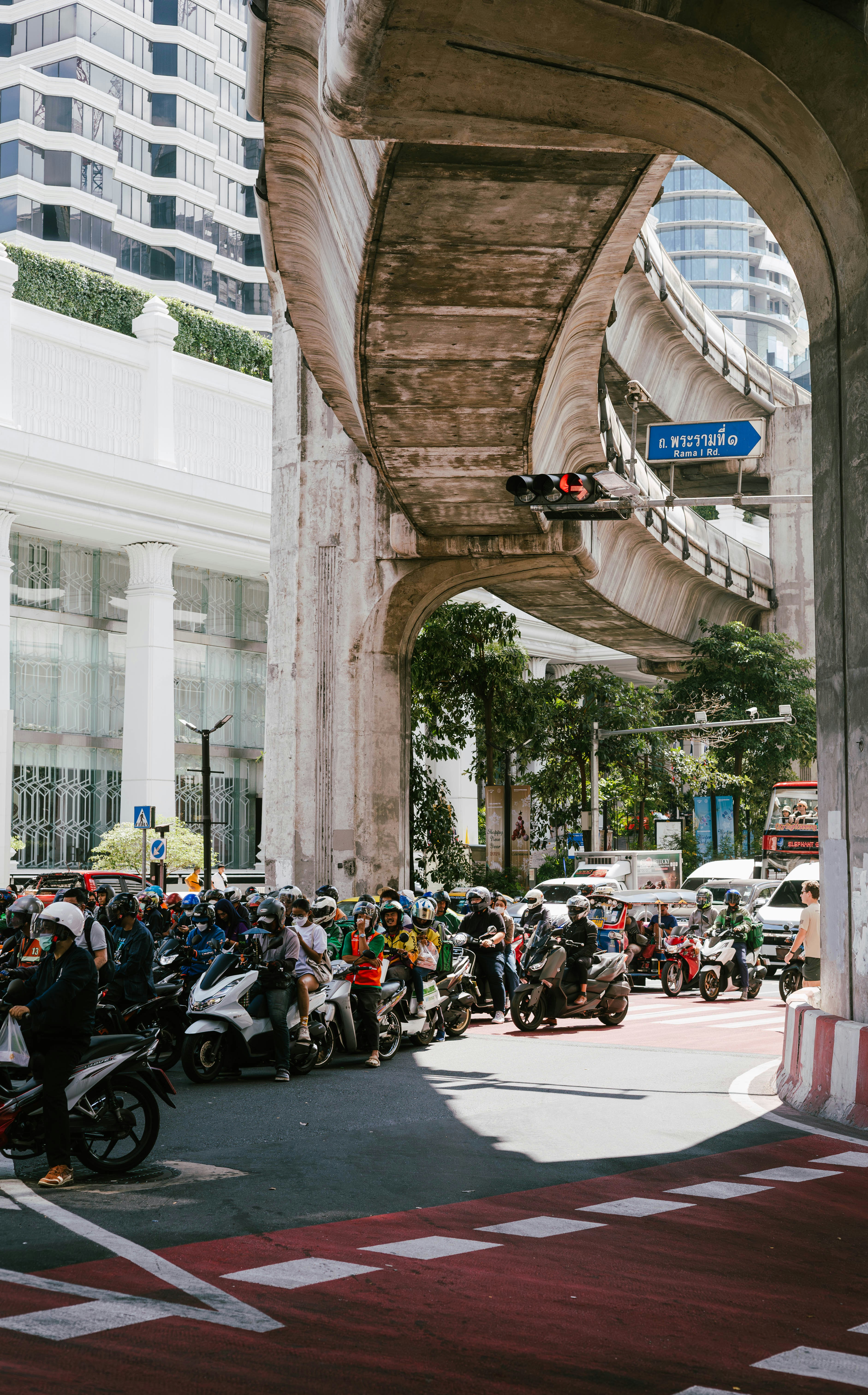A large group of people riding motorcycles under a bridge photo – Free ...