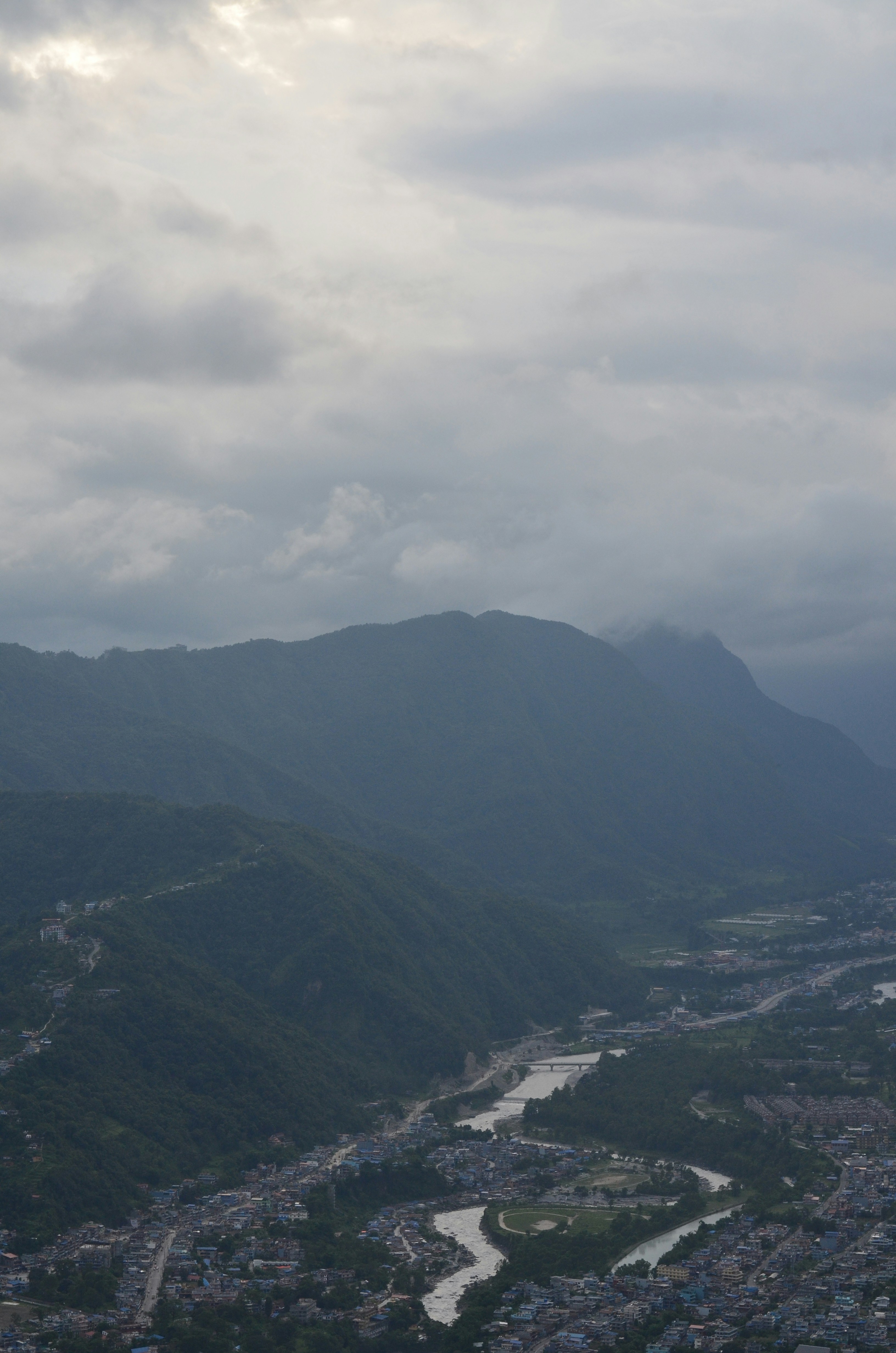 River’s Ribbon Over the Valley: A Cloud-Wrapped Panorama