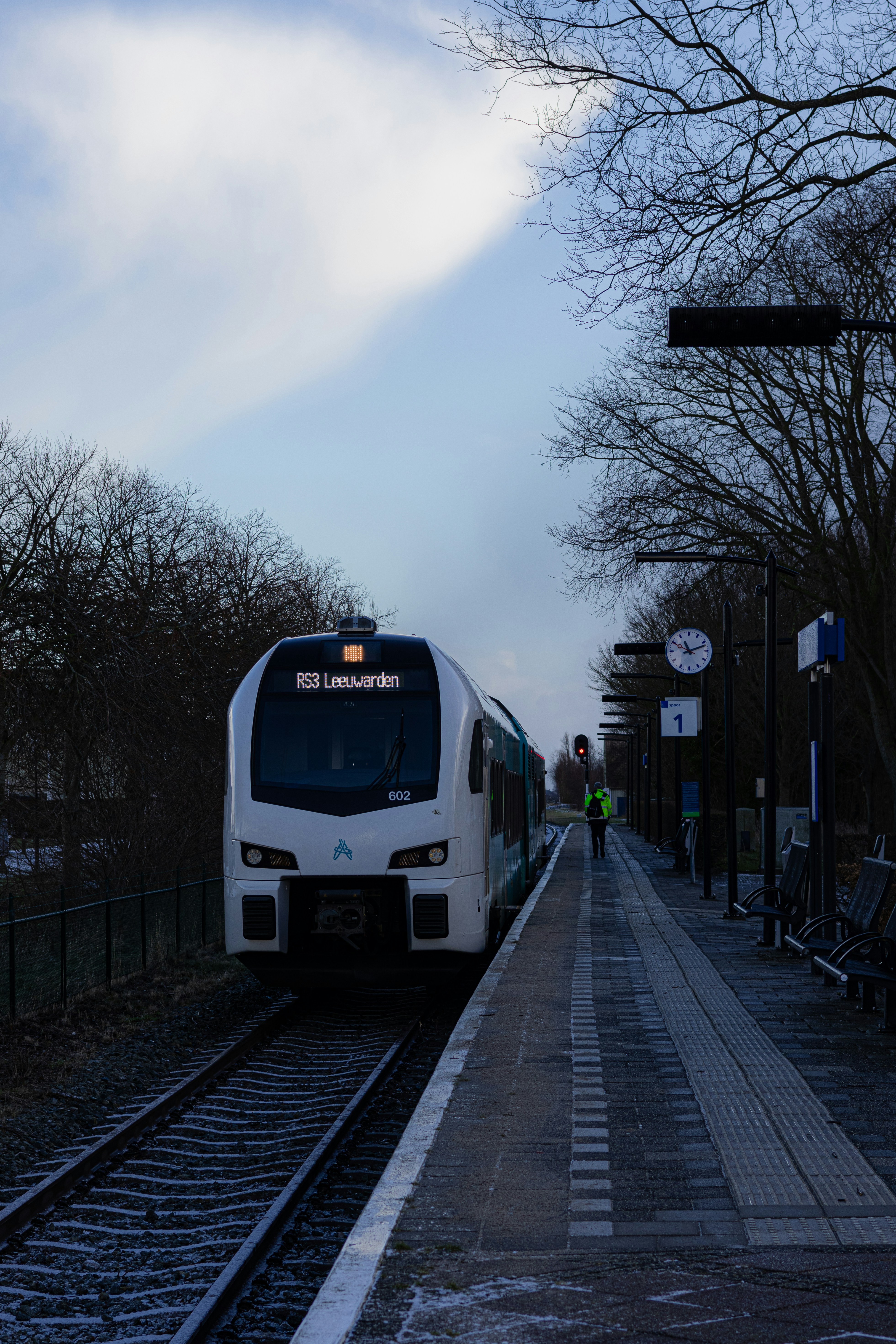 A white train pulling into a train station photo – Free Stavoren Image ...
