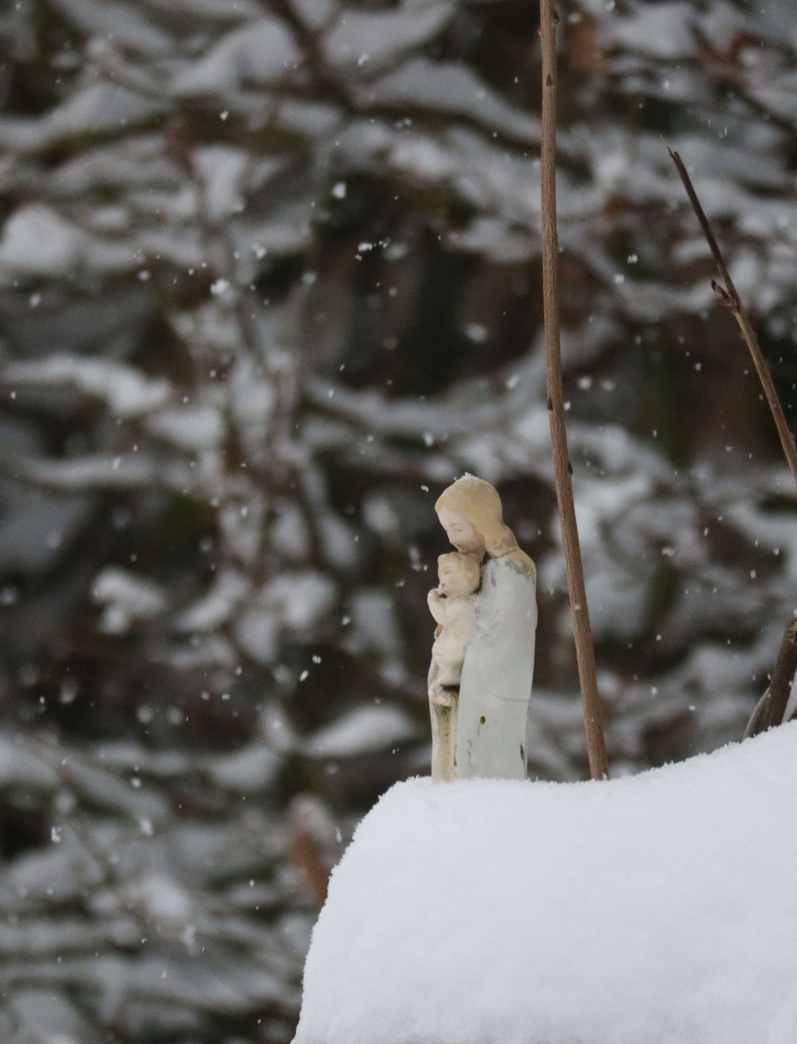 Statue in the snow of Mary with Jesus holding globe and blessing 17.1.24