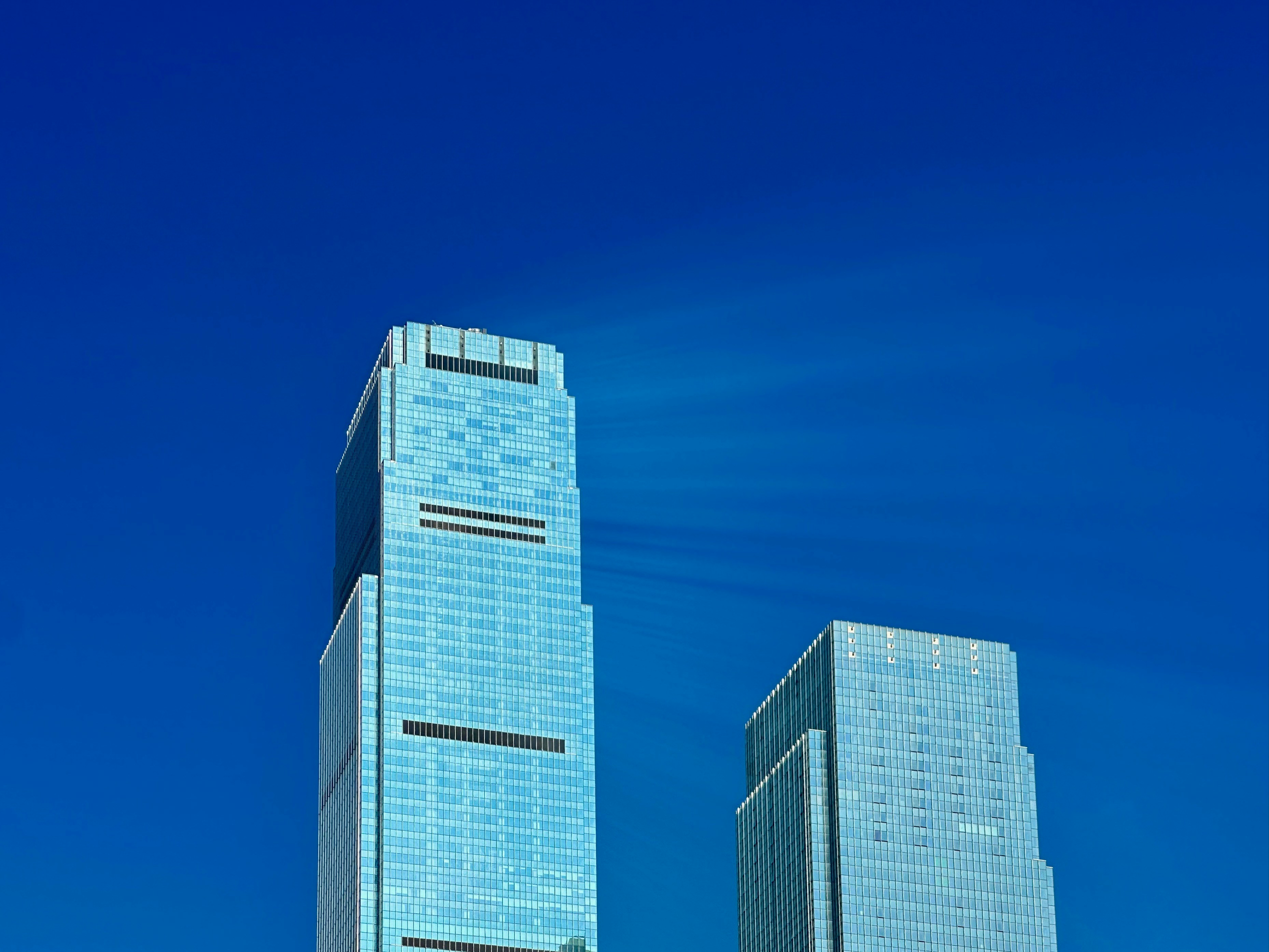 A couple of tall buildings sitting next to each other photo – Free ...
