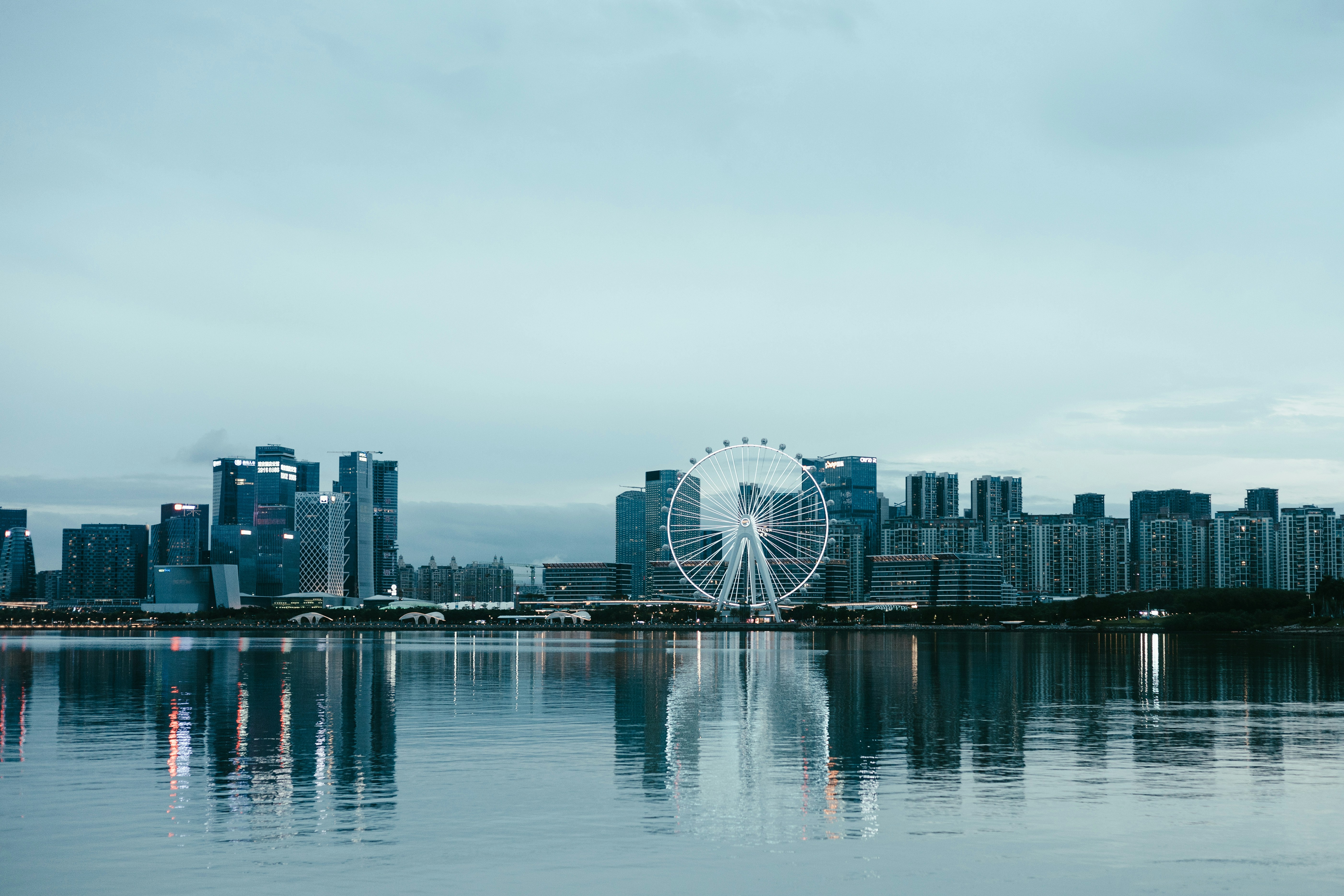 City Lights Reflect on Still Waters by the Ferris Wheel