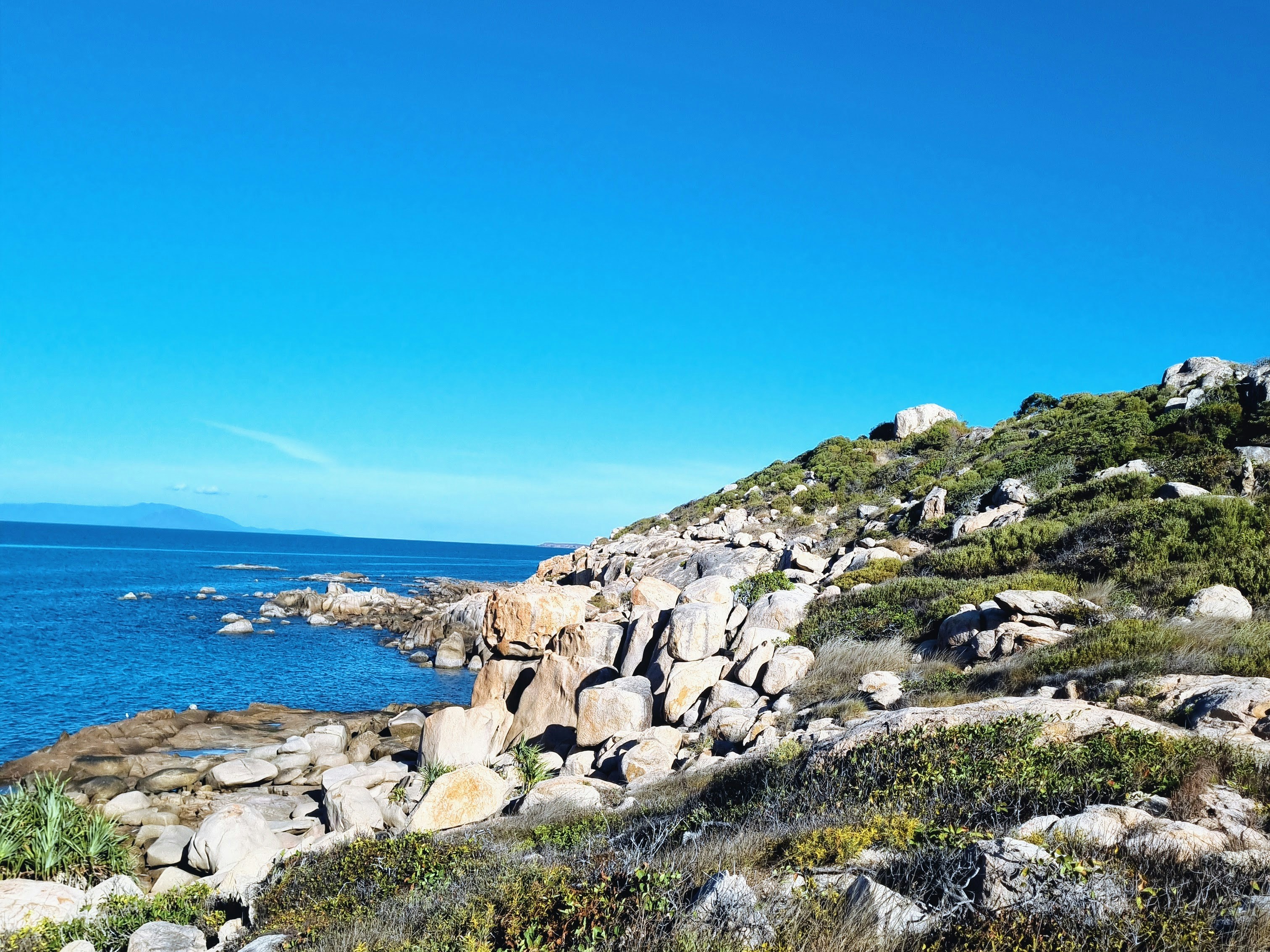 Granite Promenade: Sunlit Rocks Guard an Open Sea