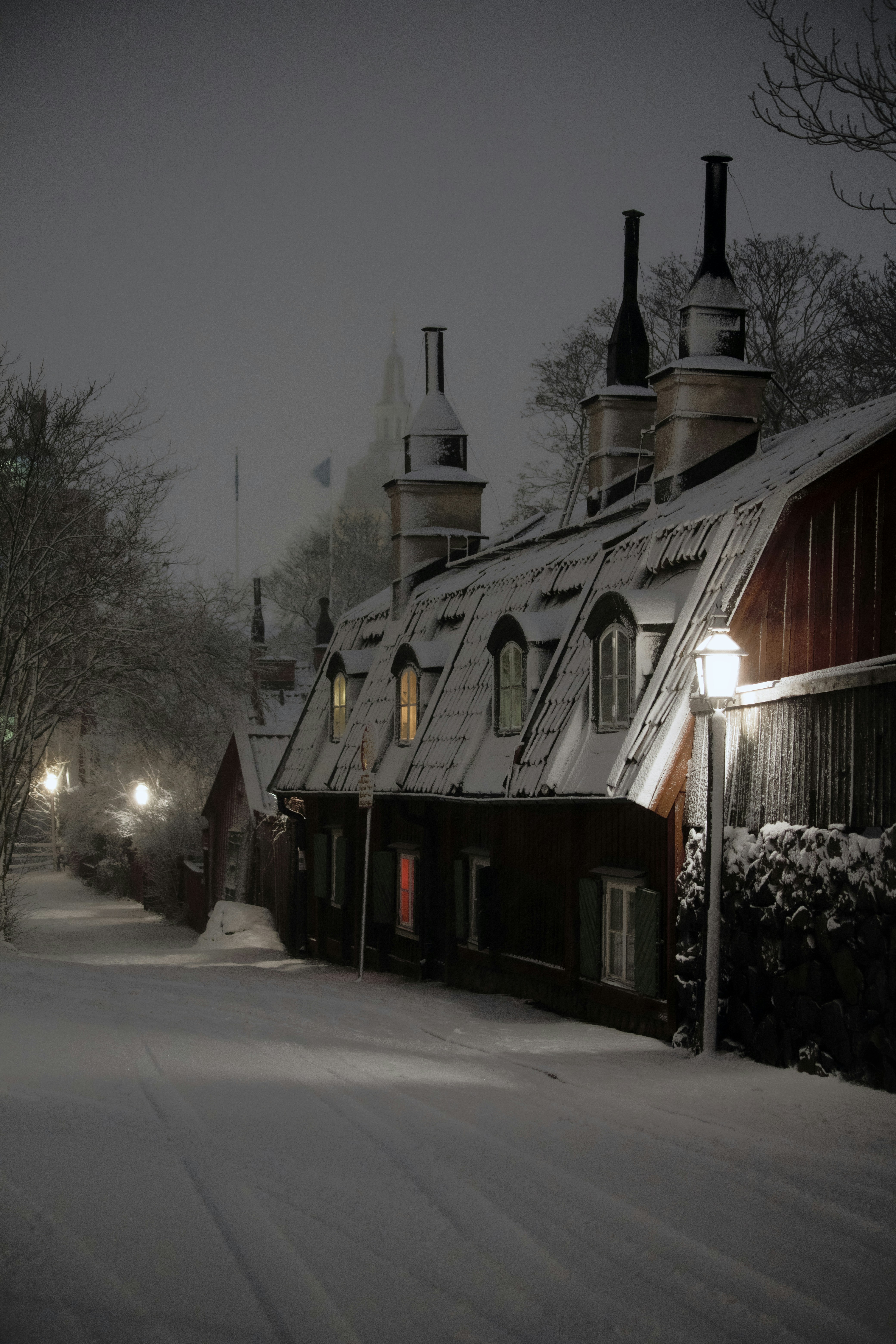Lanterns Against Snow: A Silent Alpine Street at Dusk