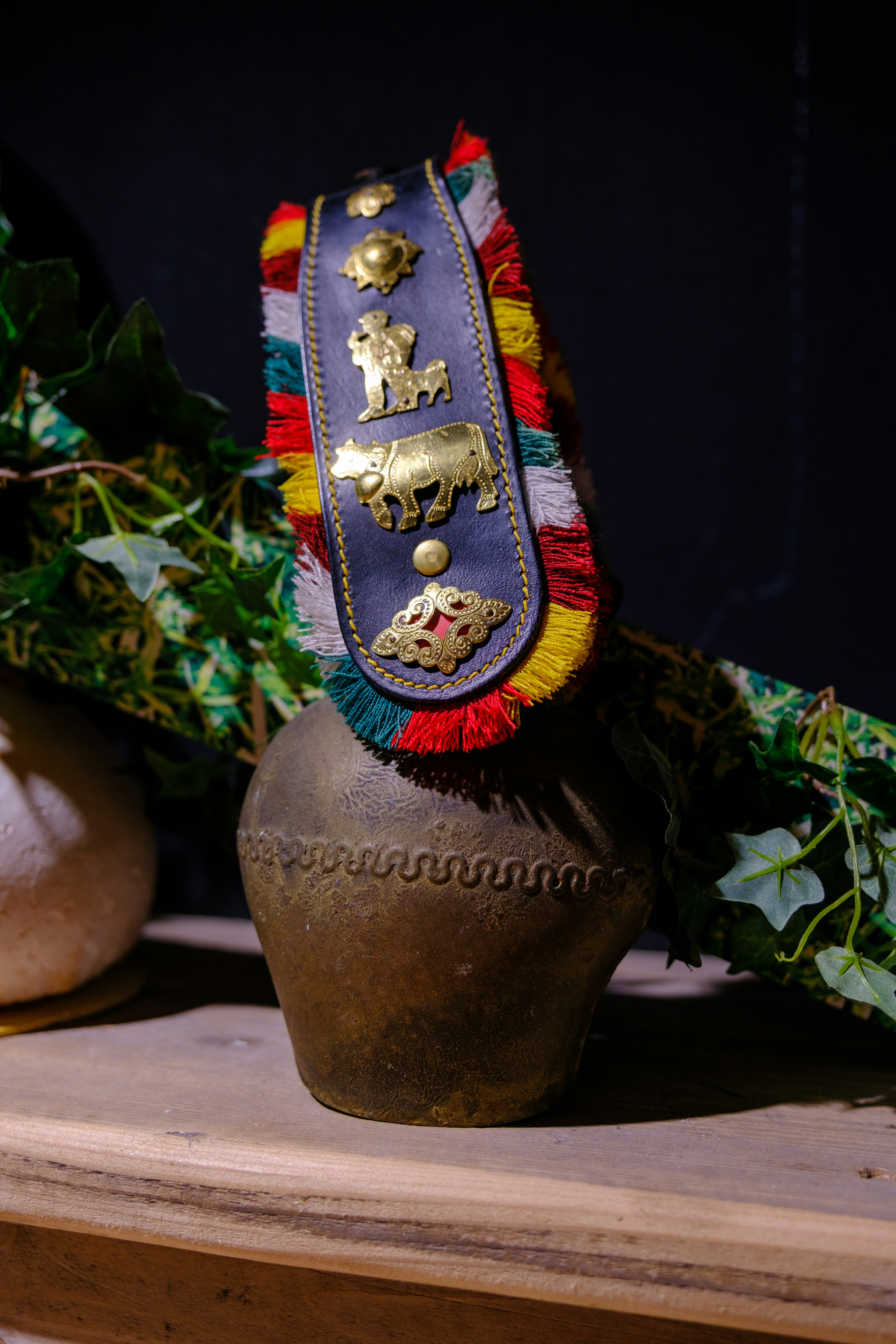 Gold-Embellished Ribbon Draped Across a Weathered Vase