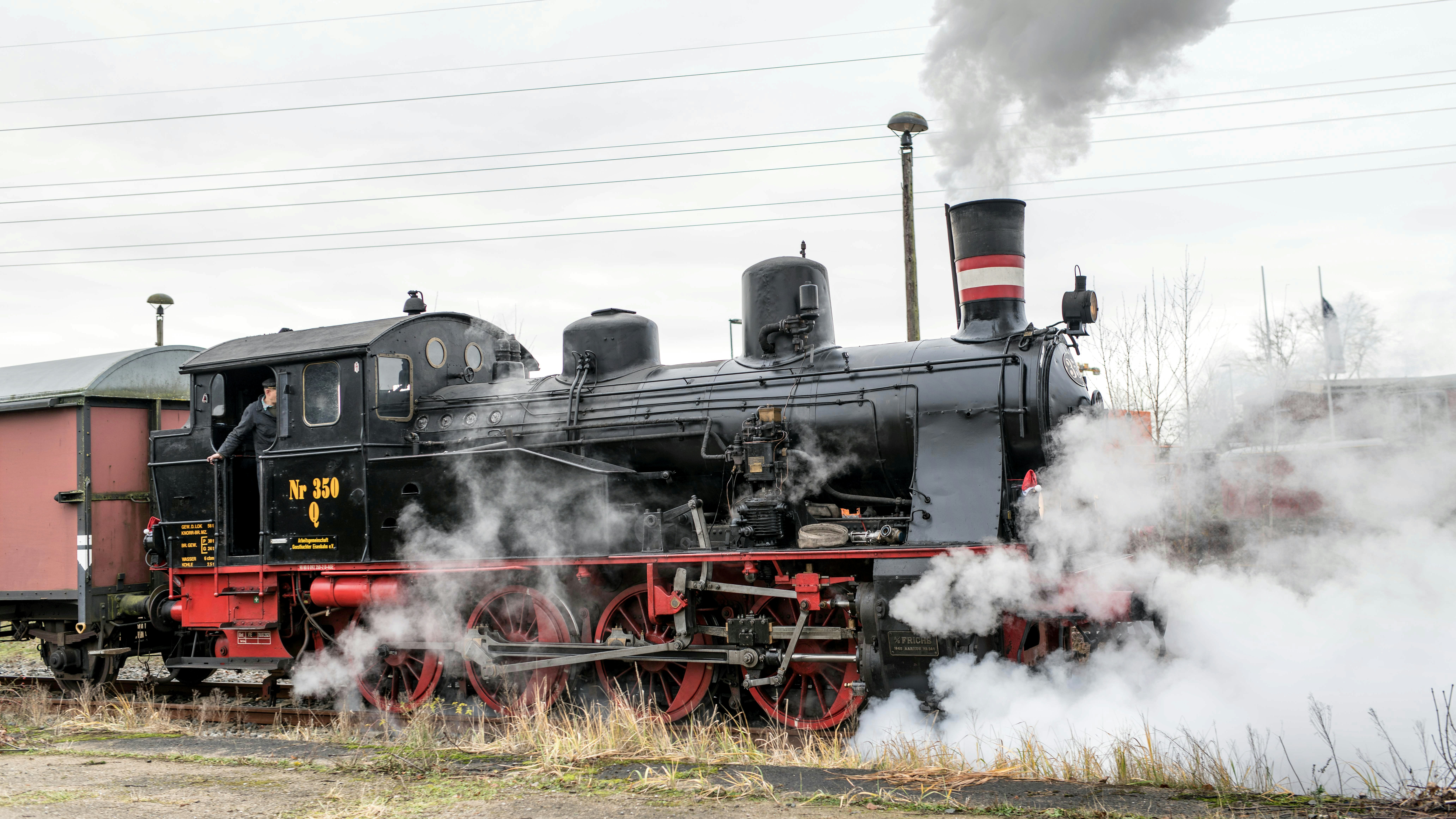 A steam engine train traveling down train tracks photo – Free Retro ...