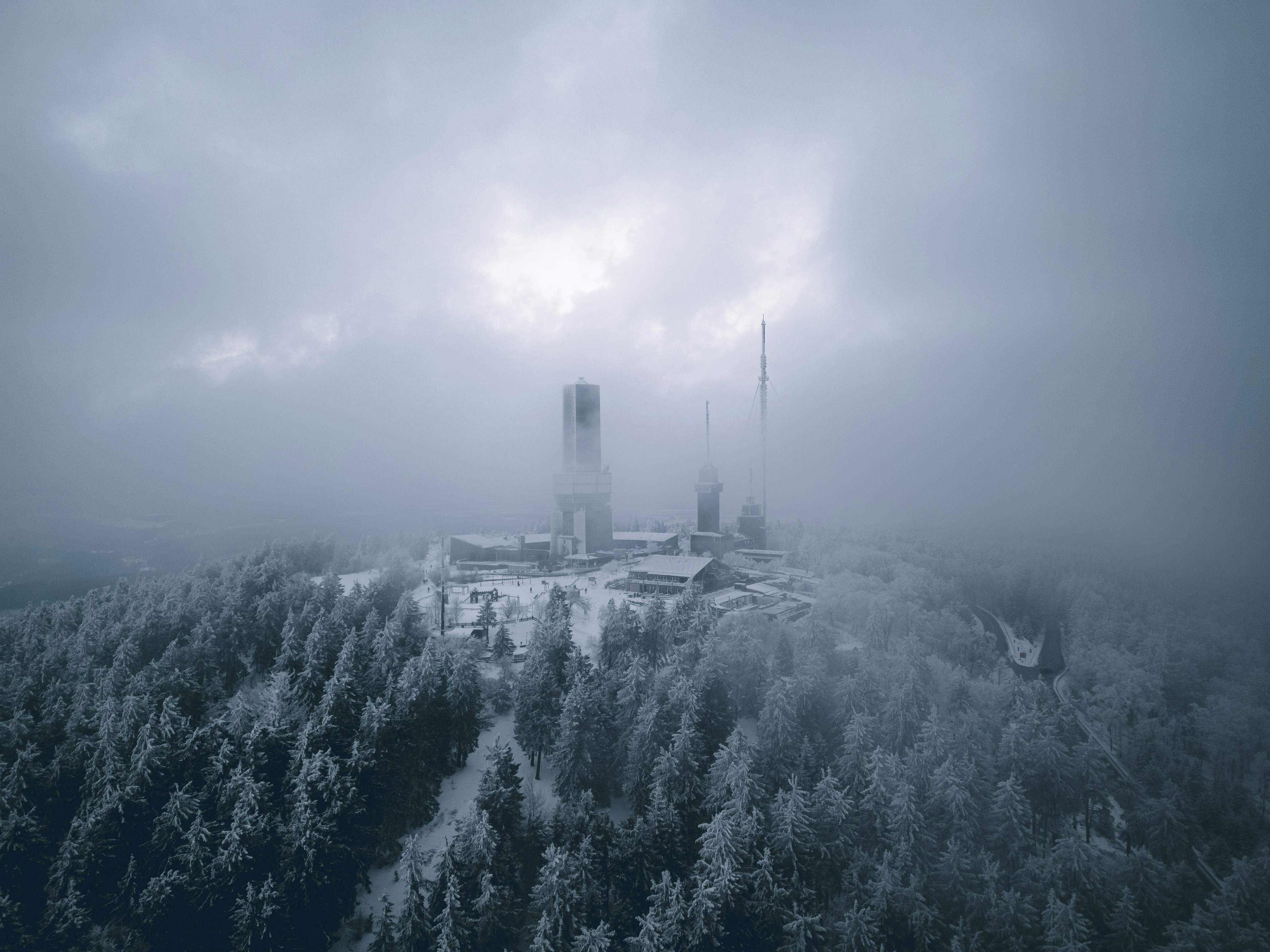 Fog-Wrapped Summit: A Sentinel on the Misty Ridge