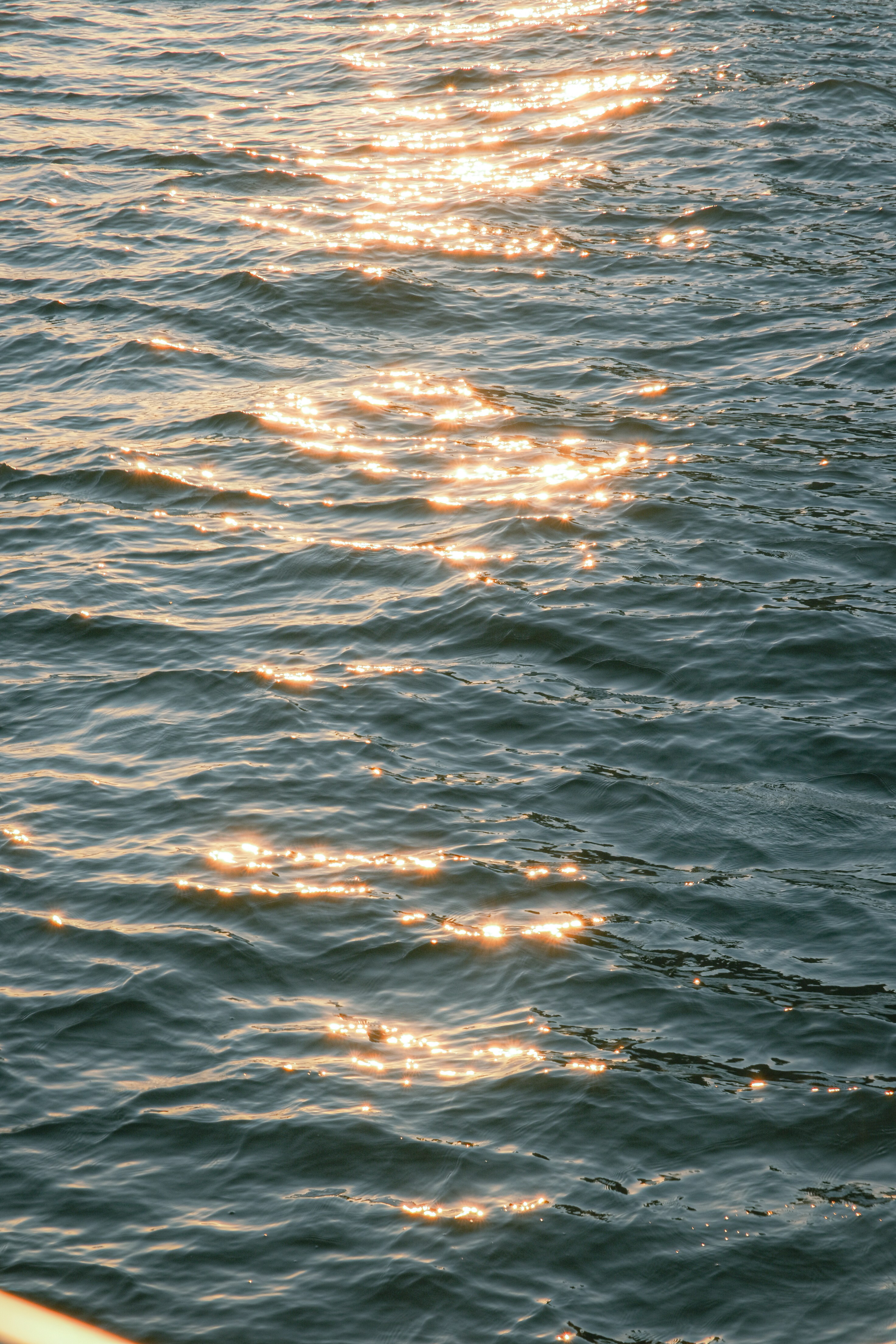 The sun shines on the water as it reflects off the surface of the water ...