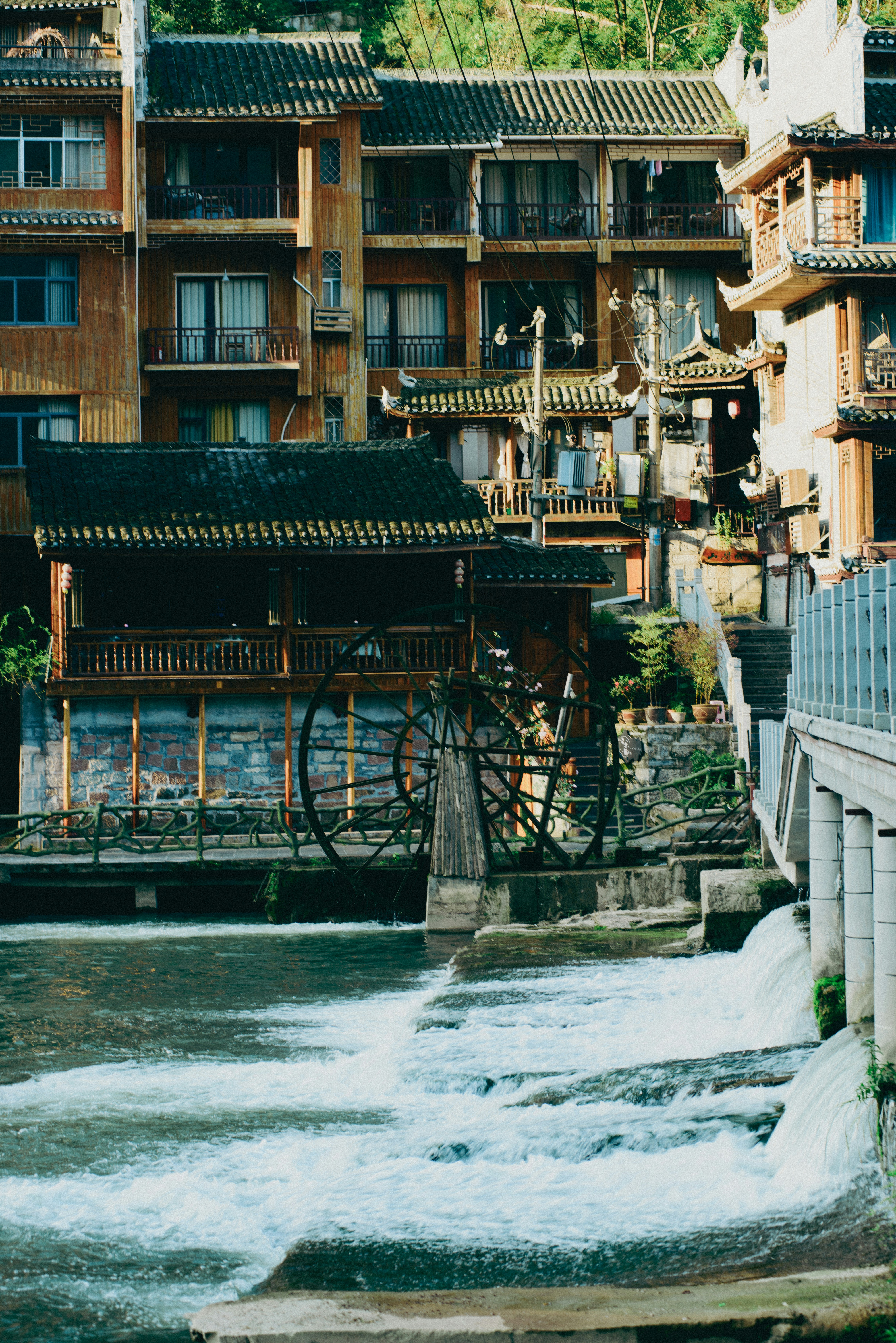 Water Wheel and Wooden Village: A Riverfront Tale