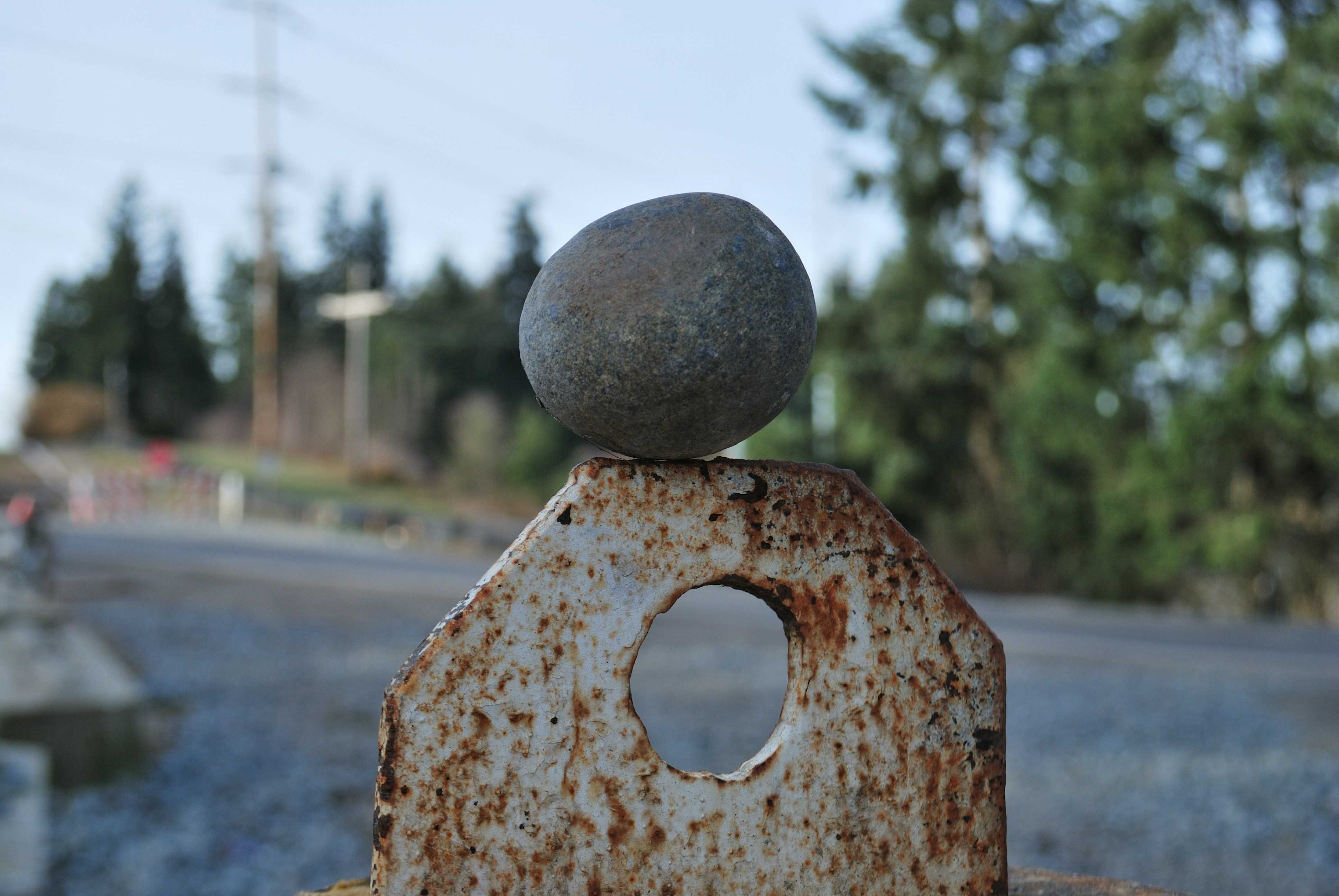 A rusted metal object sitting on the side of a road photo – Free Grey ...