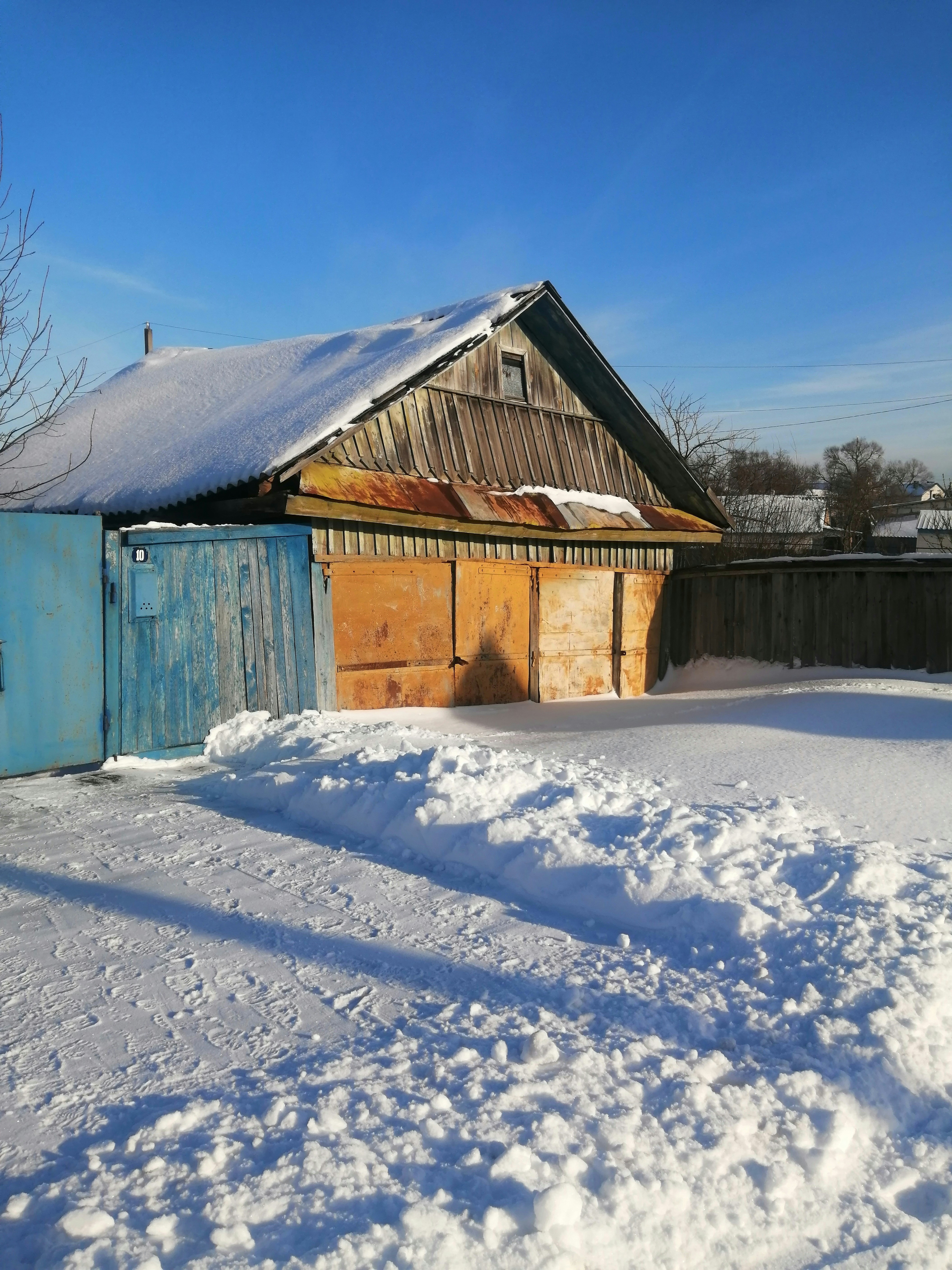 Snowbound Farmstead: Blue Gates Framing a Weathered Barn Under a Pristine Winter Sky