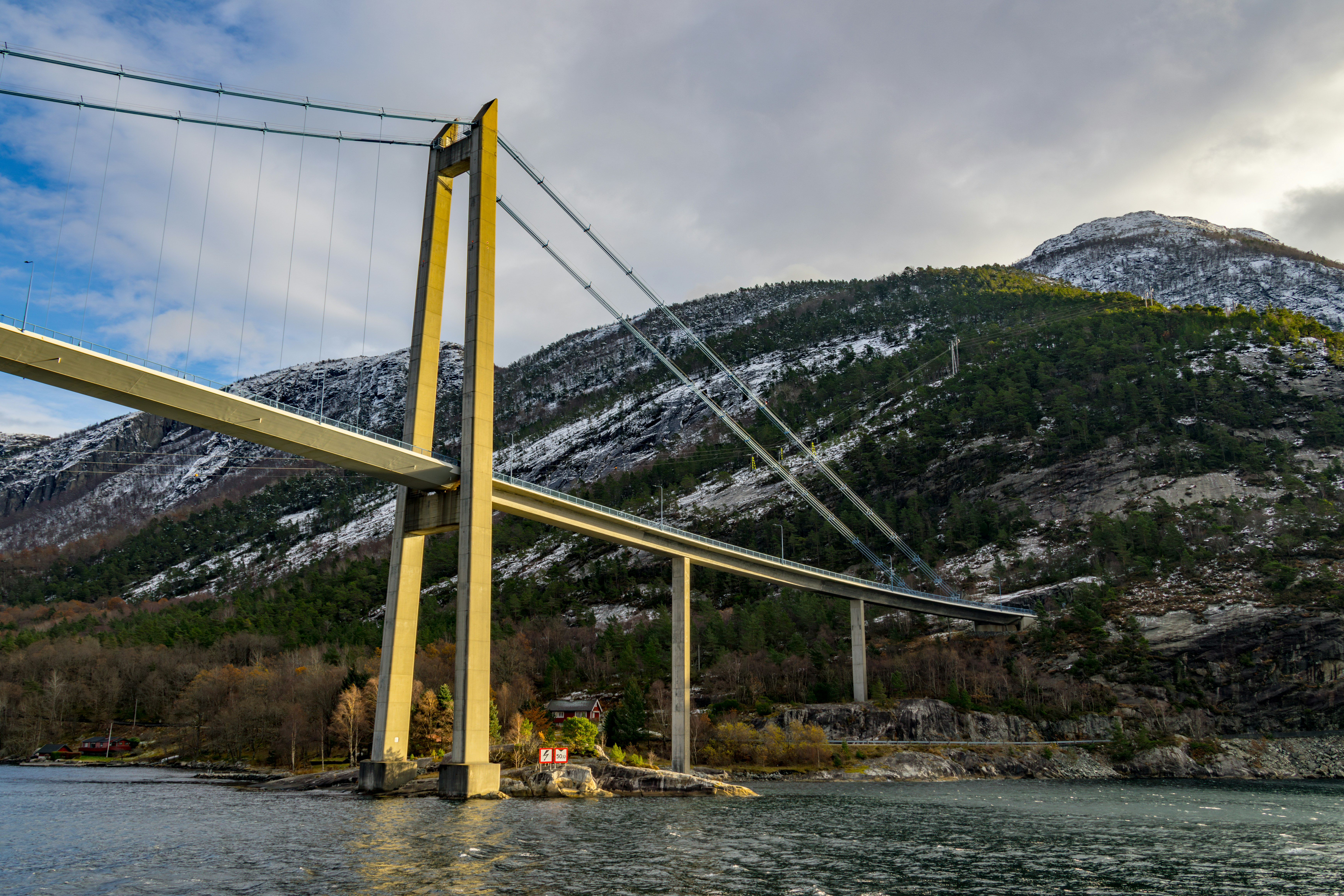 Snow-kissed Cable-Stayed Span Looms Over Quiet River