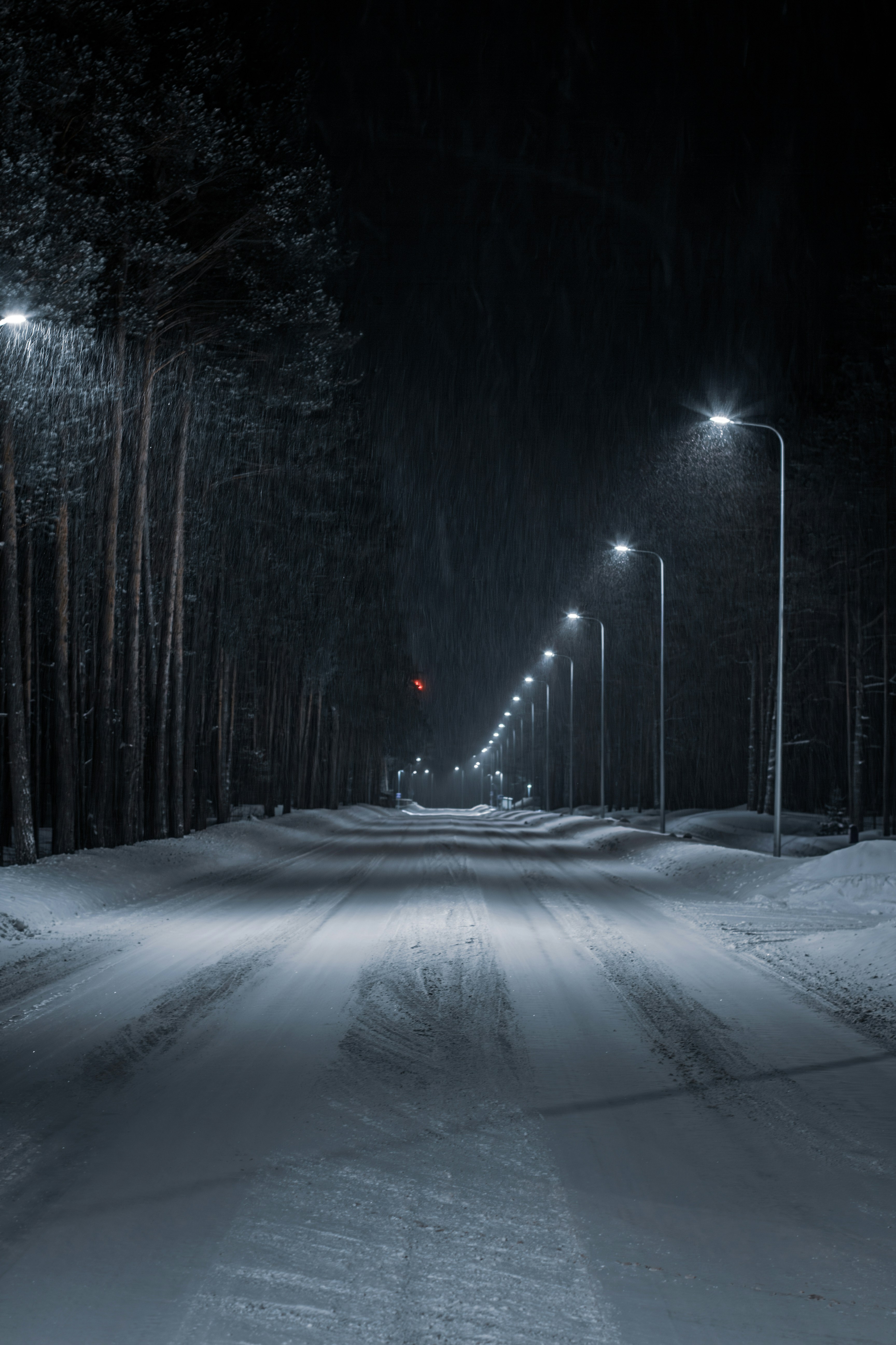 A snowy road at night with street lights photo – Free Black Image on ...