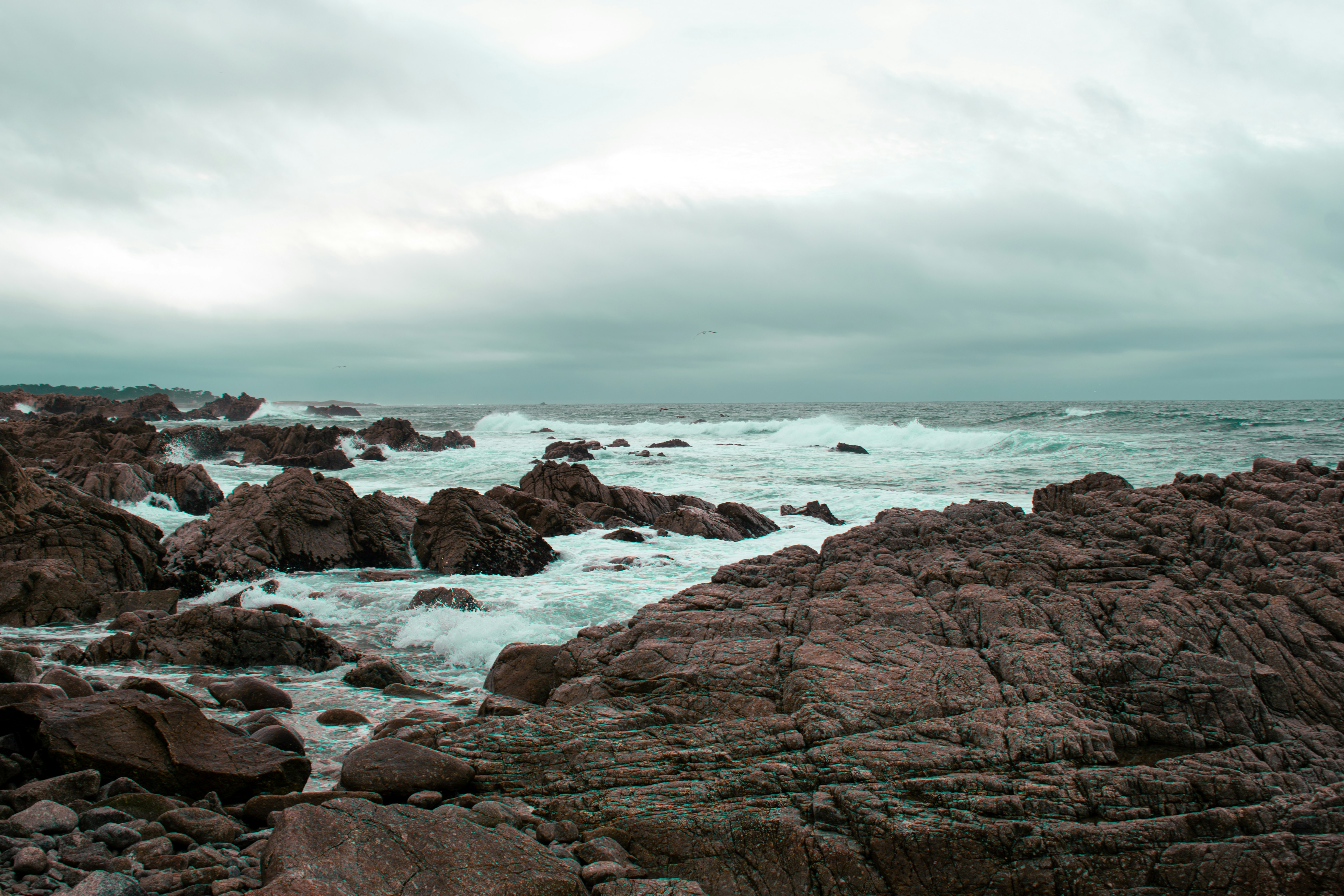 A rocky beach with waves crashing on the rocks photo – Free Wallpaper ...