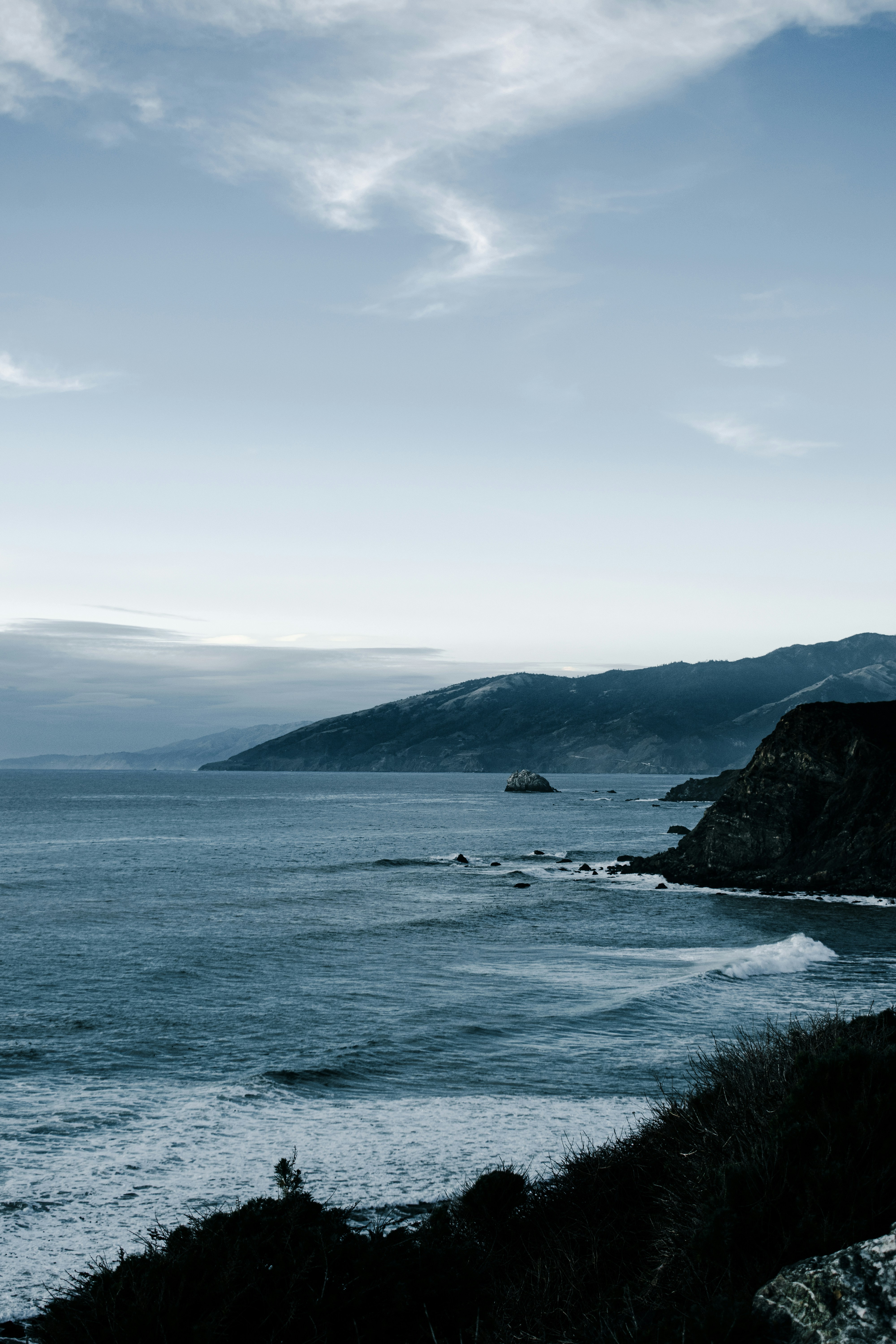 a view of a body of water with mountains in the background
